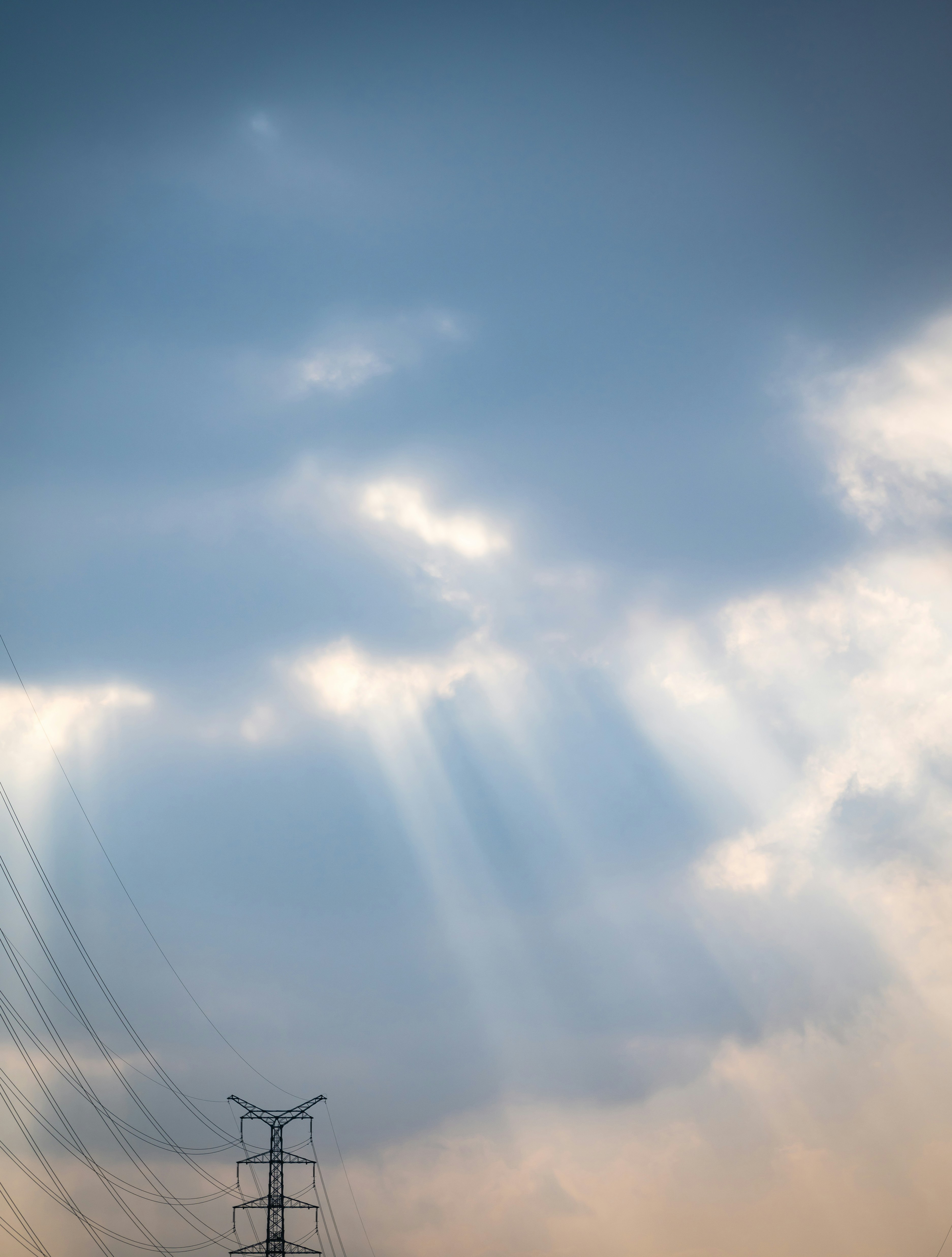 Beams Through a Clouded Sky Over a Distant Substation