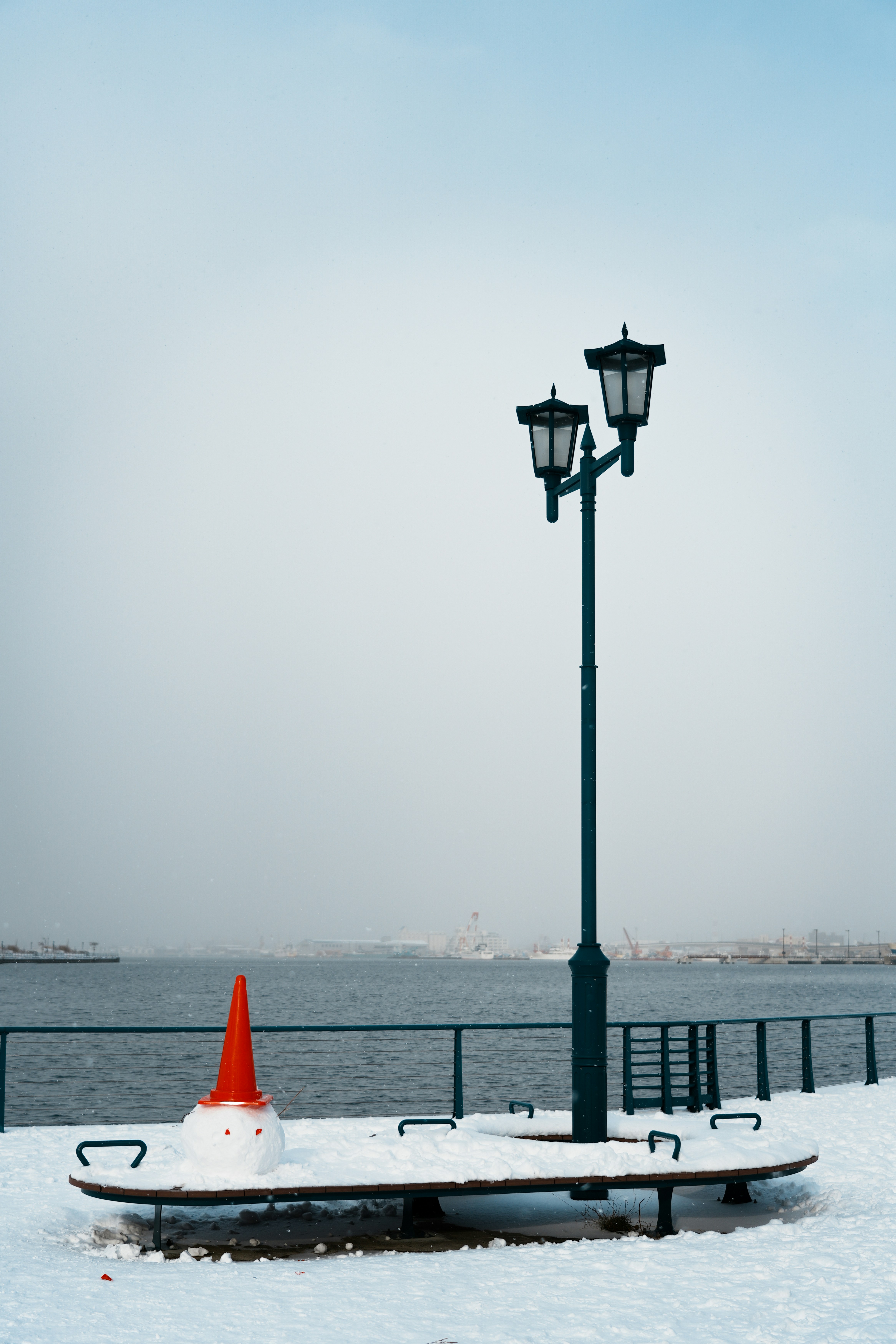 Snowbound Lantern Over a Quiet Harbor
