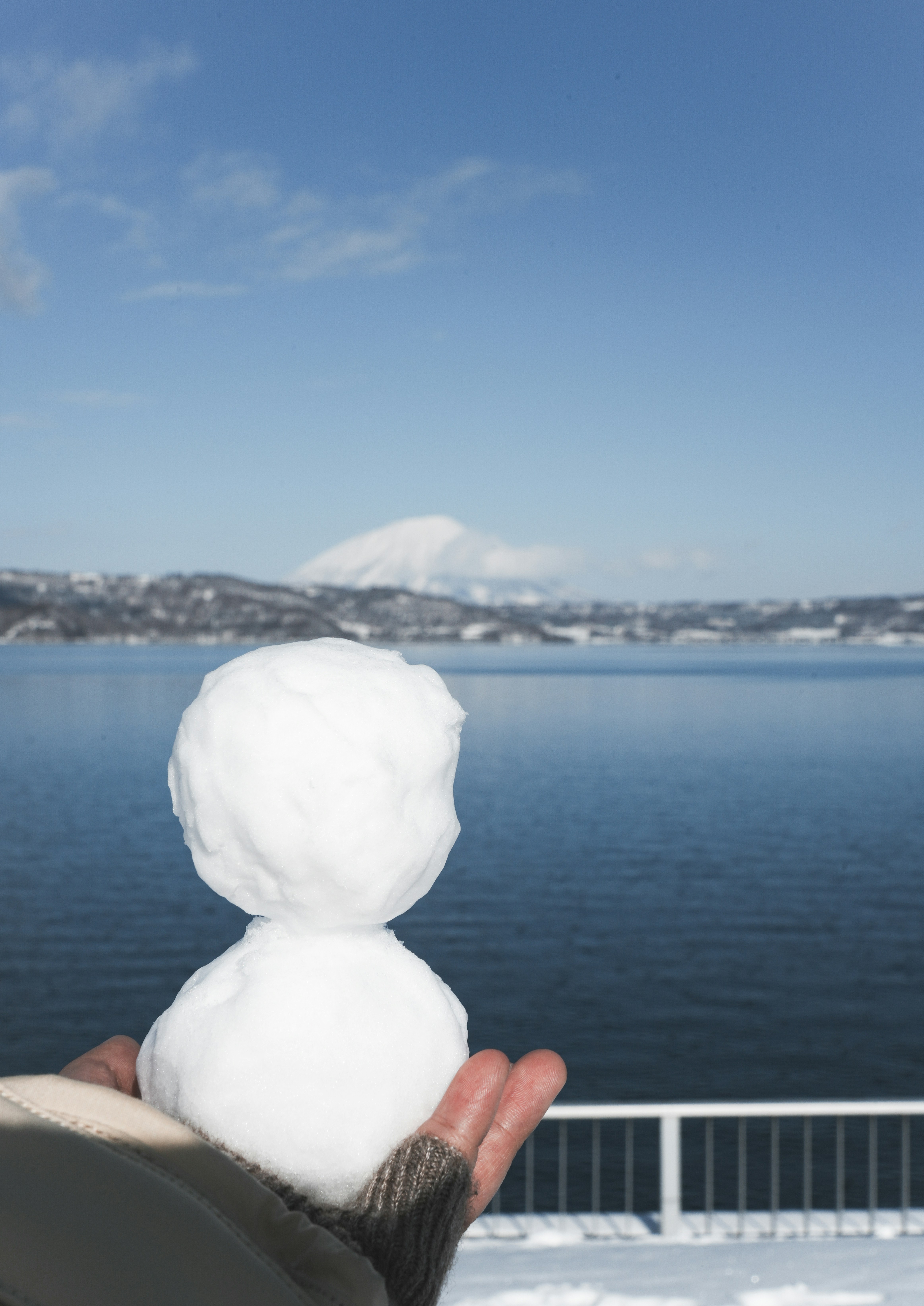 Snow in Hand, Fjord in Frame: A Quiet Winter Portrait