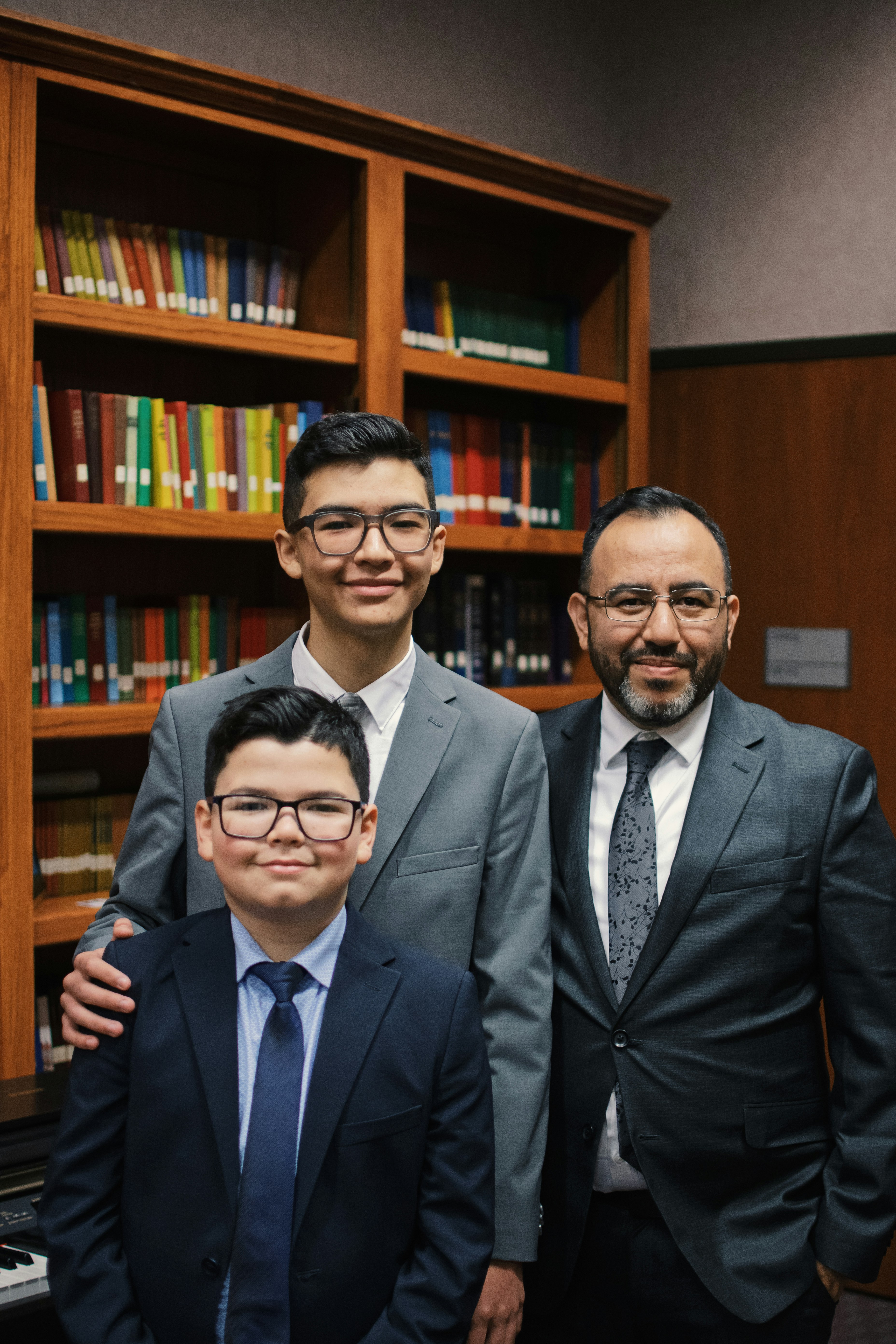 A group of three men standing next to each other photo – Free Portrait ...