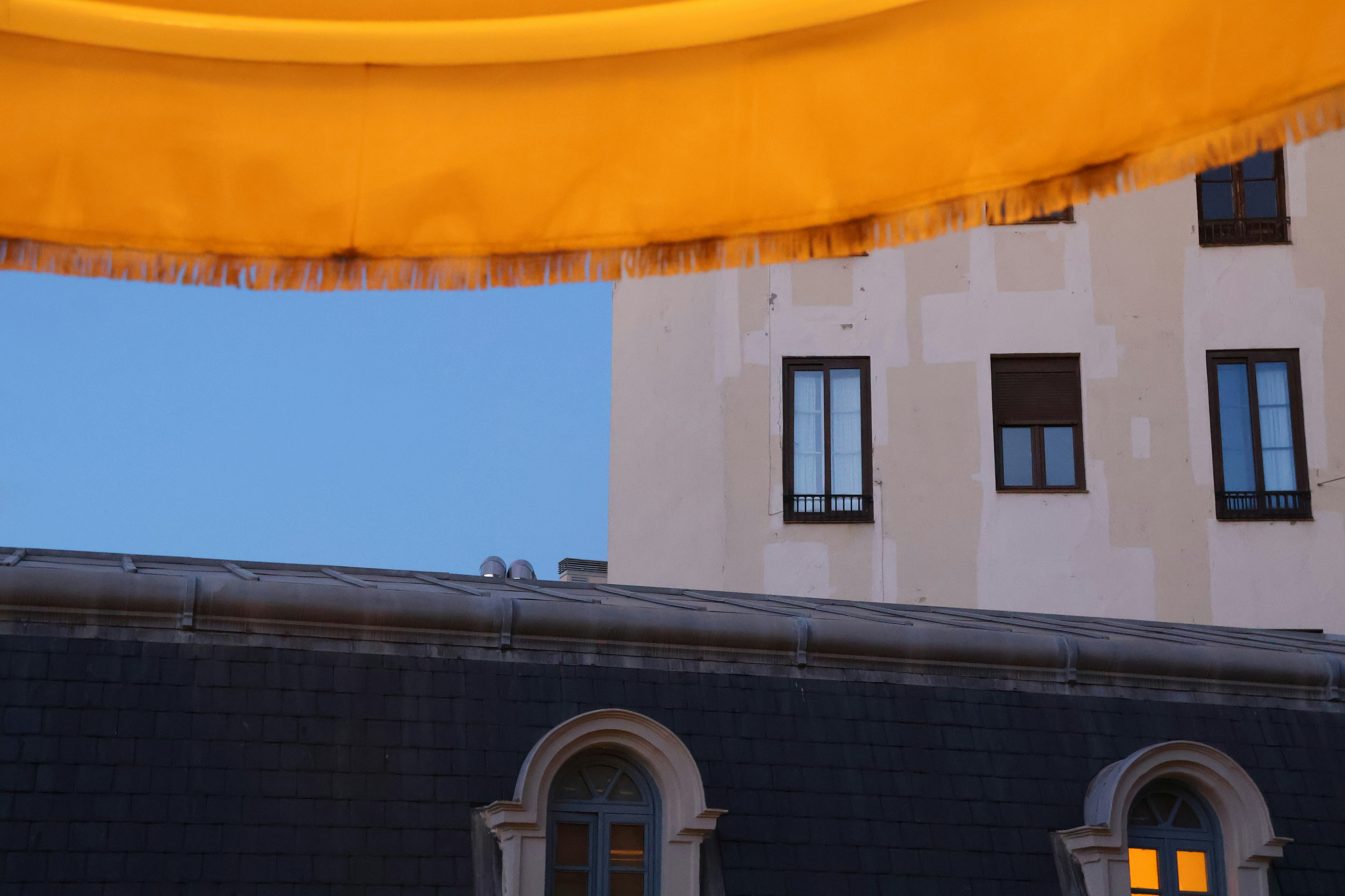 Amber Canopy Framing a Quiet European Façade