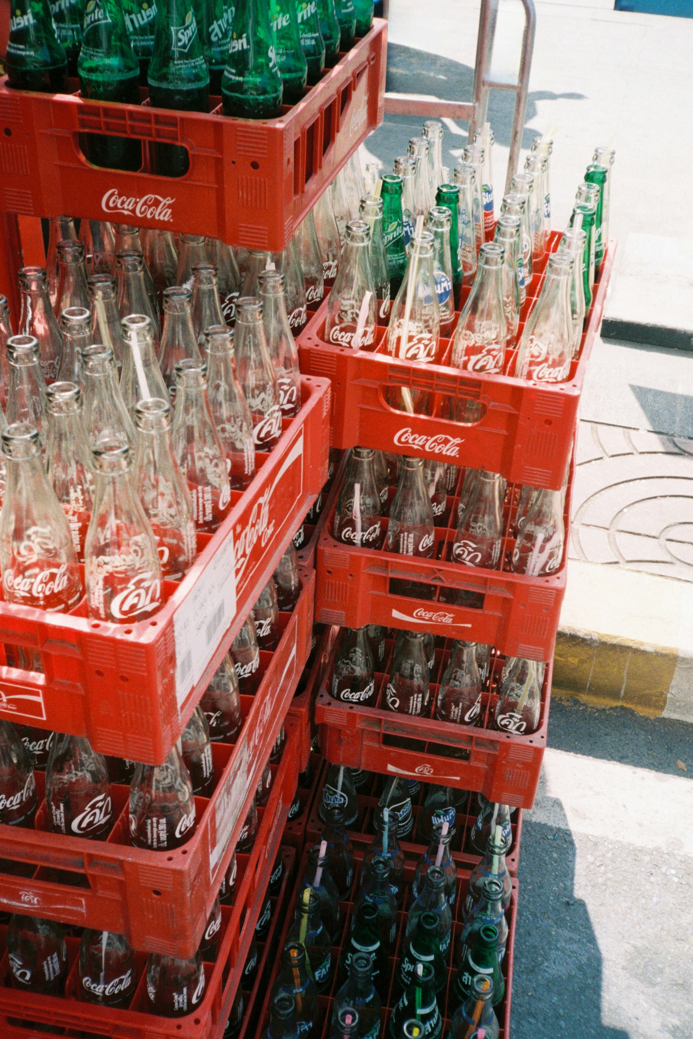 A red cart filled with lots of empty coke bottles photo – Free City ...