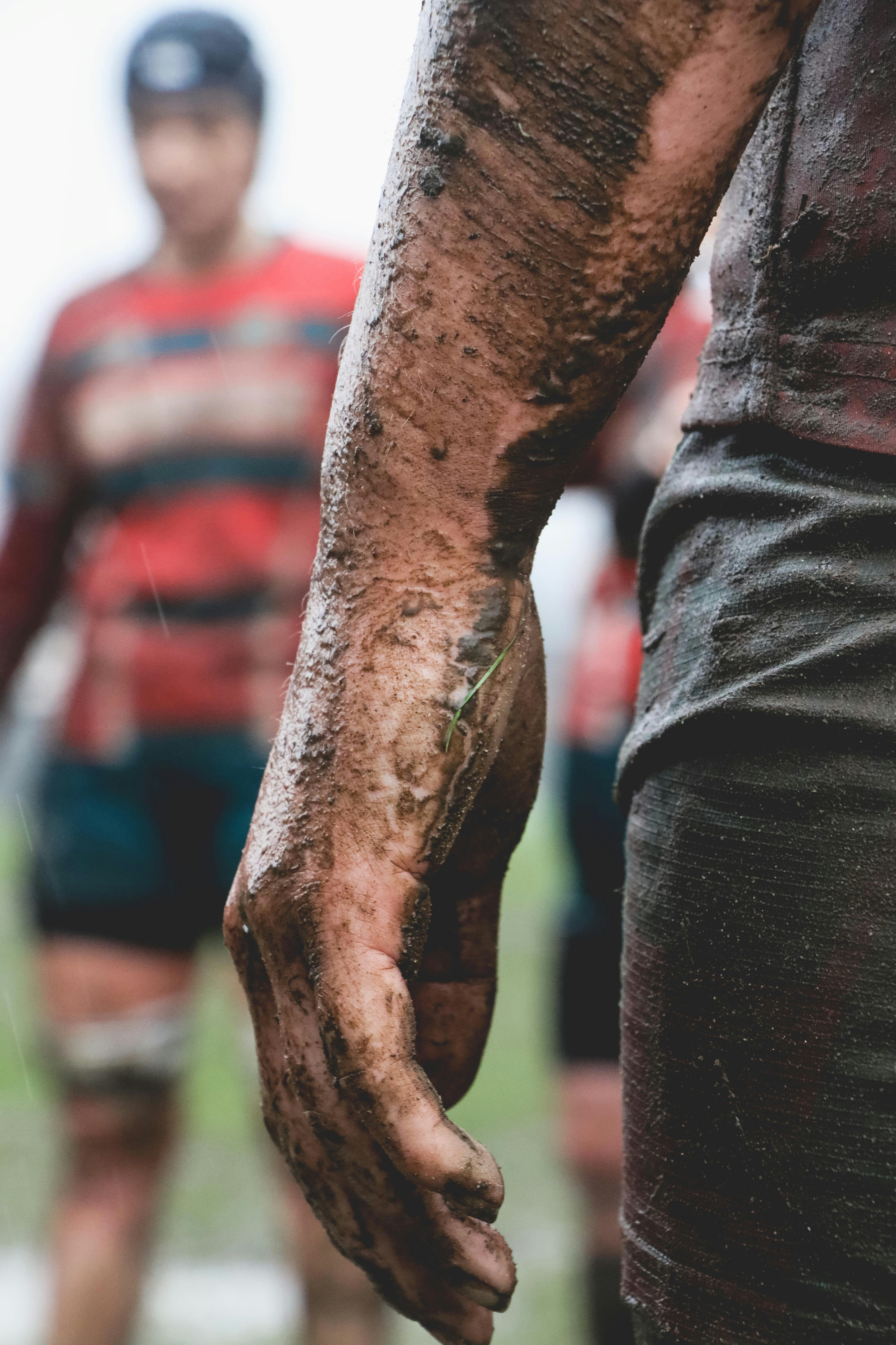 Mud-Smeared Arm: The Close-Up of a Mud-Caked Moment