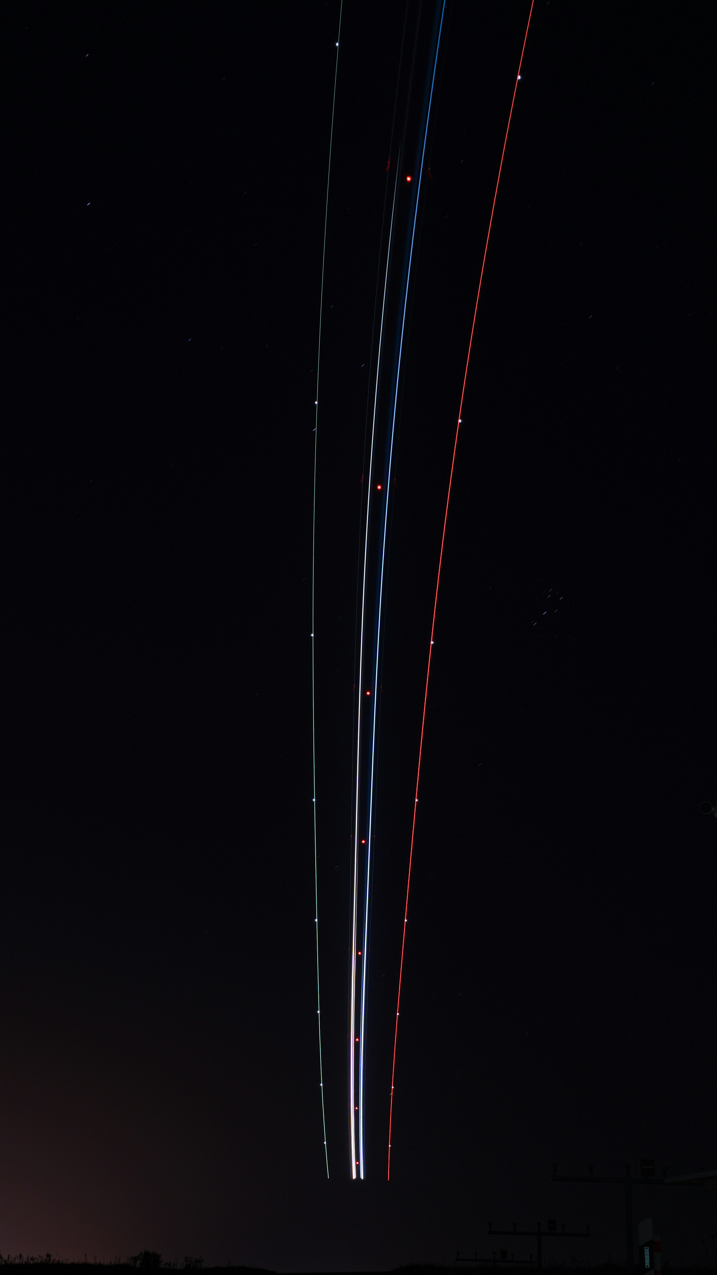 A long line of airplanes flying in the night sky photo – Free Night ...