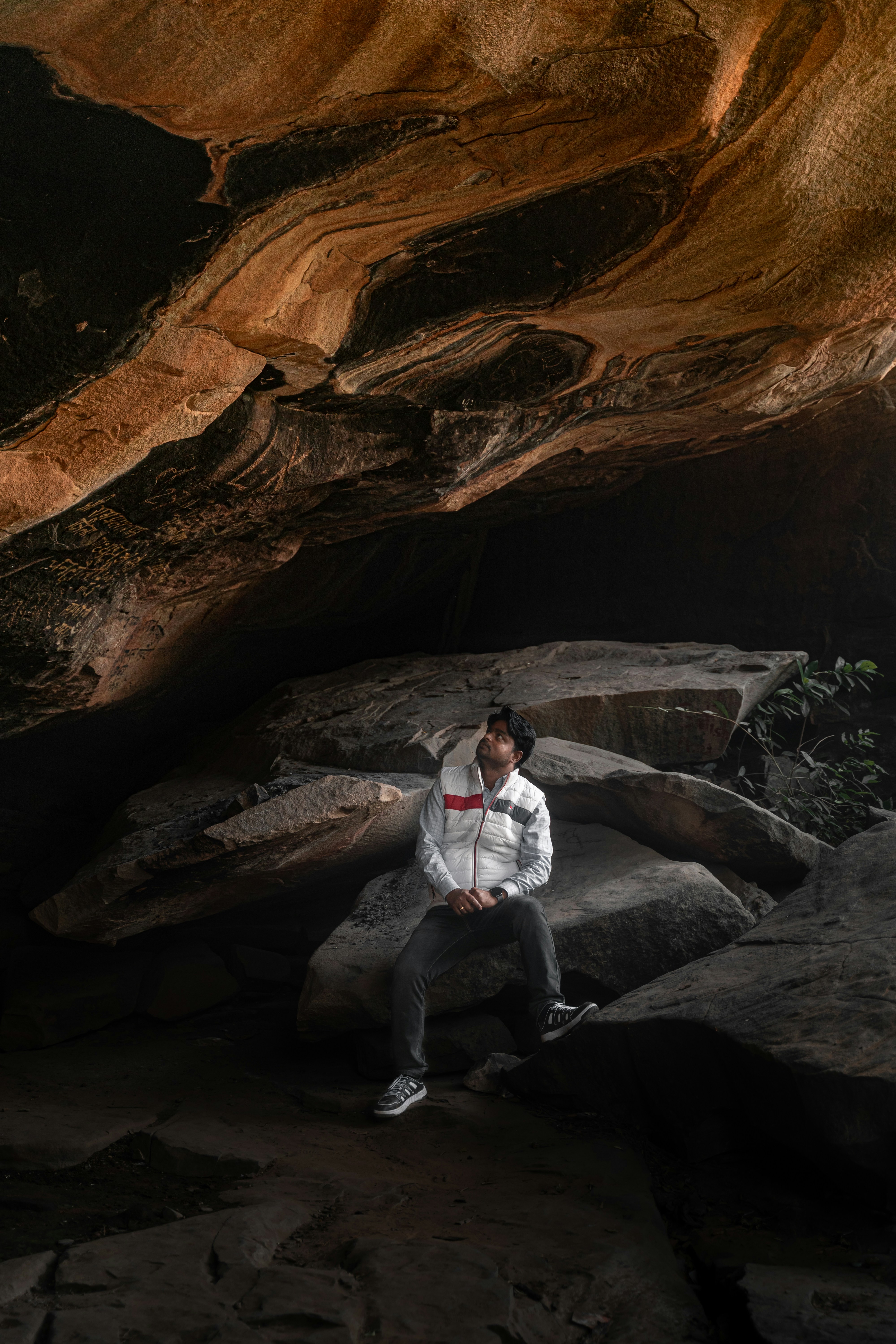 Under the Granite Canopy: A Portrait in Shadow and Warm Light