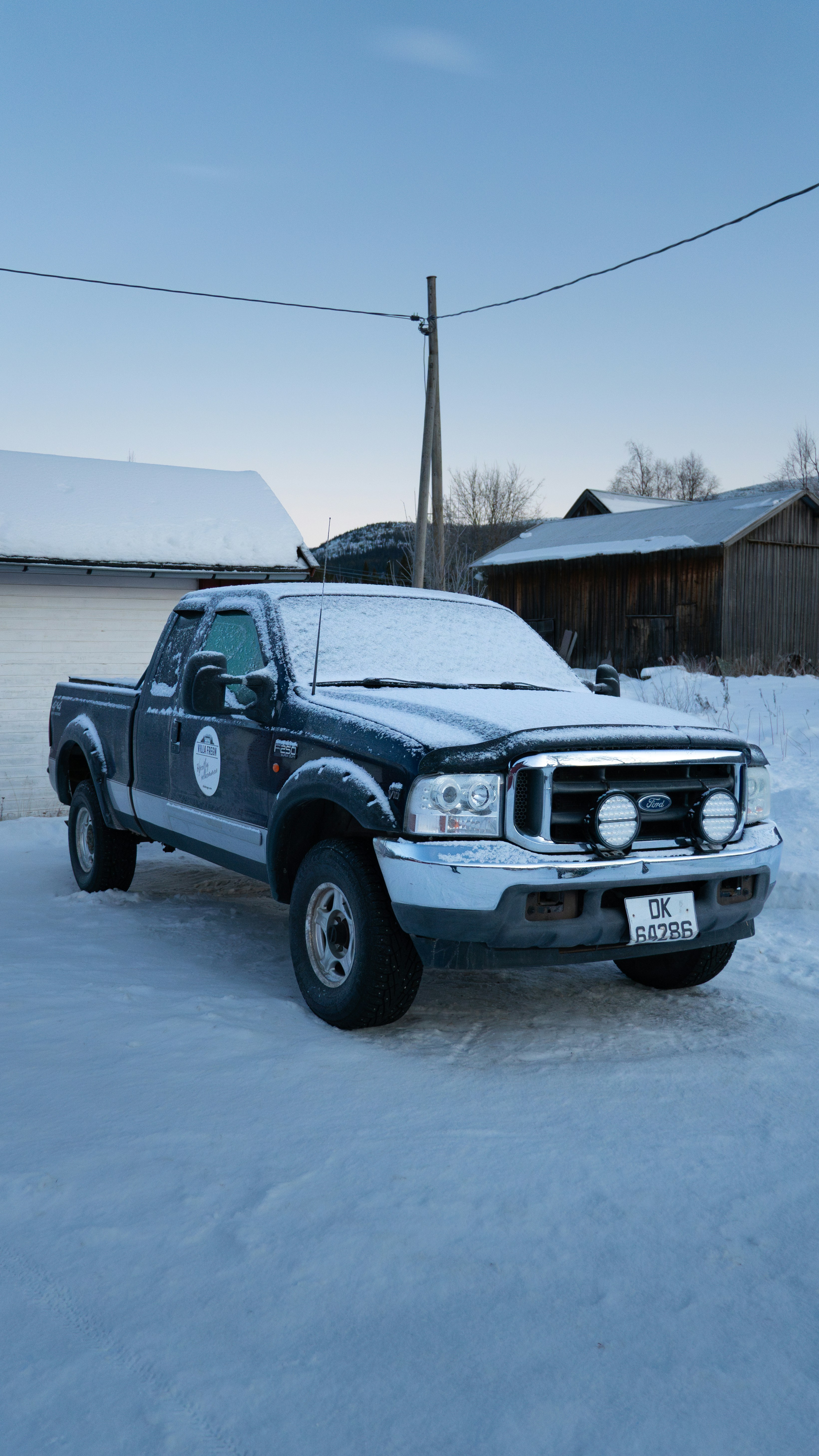 A pick up truck parked in the snow