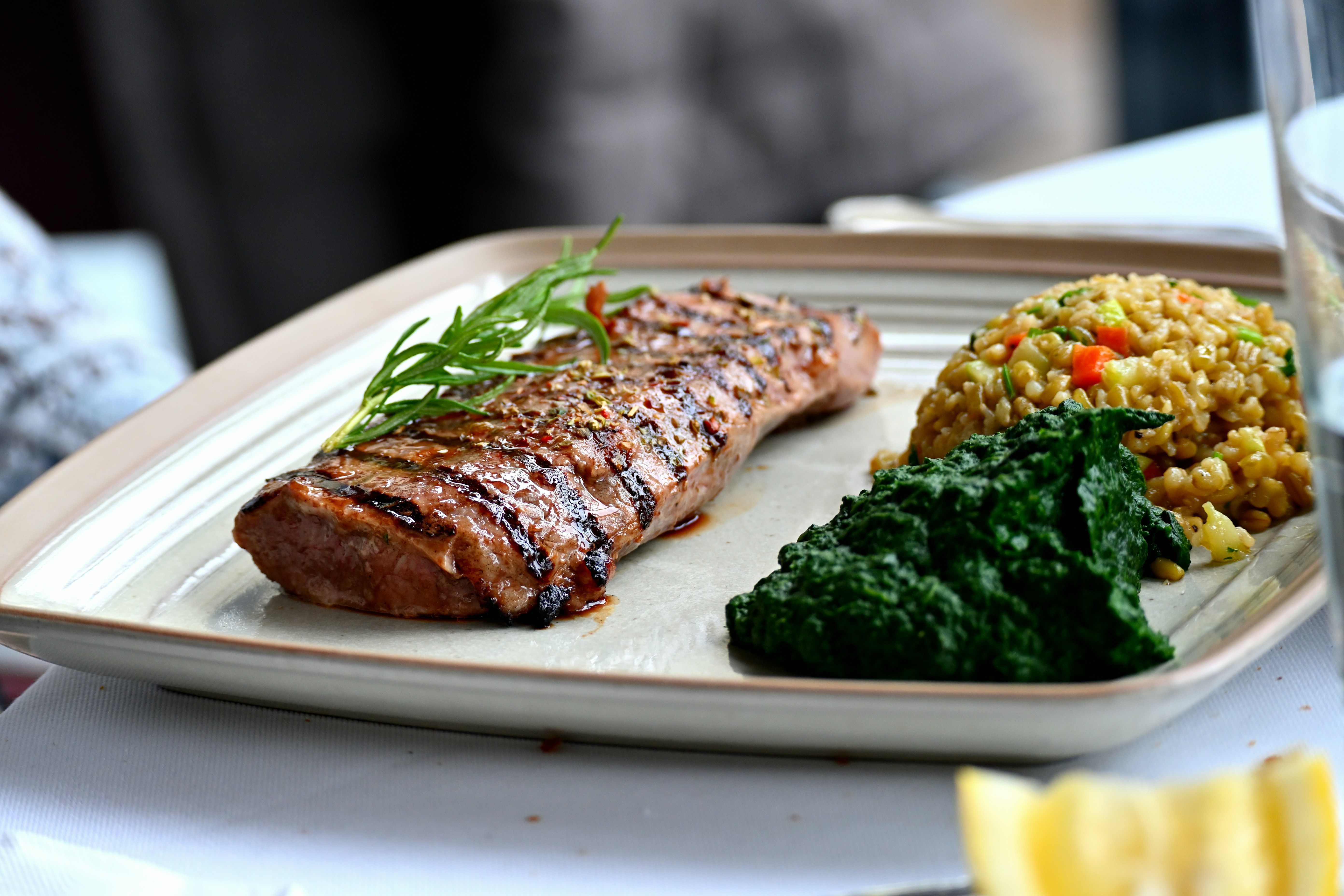 A plate of food on a table with a glass of water photo – Free Food ...