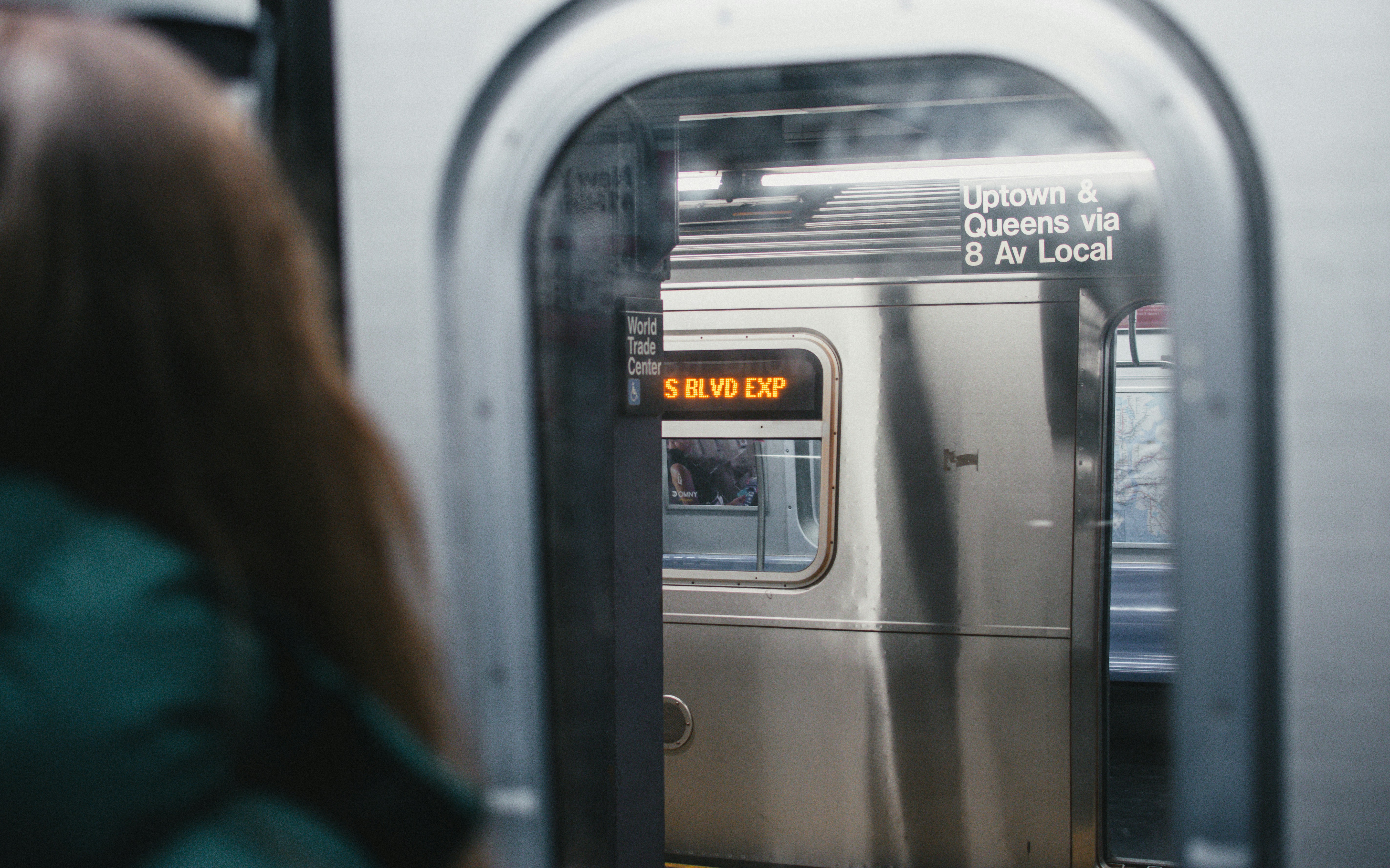 Signal in Steel: An Orange Emblem Framed by Subway Doors