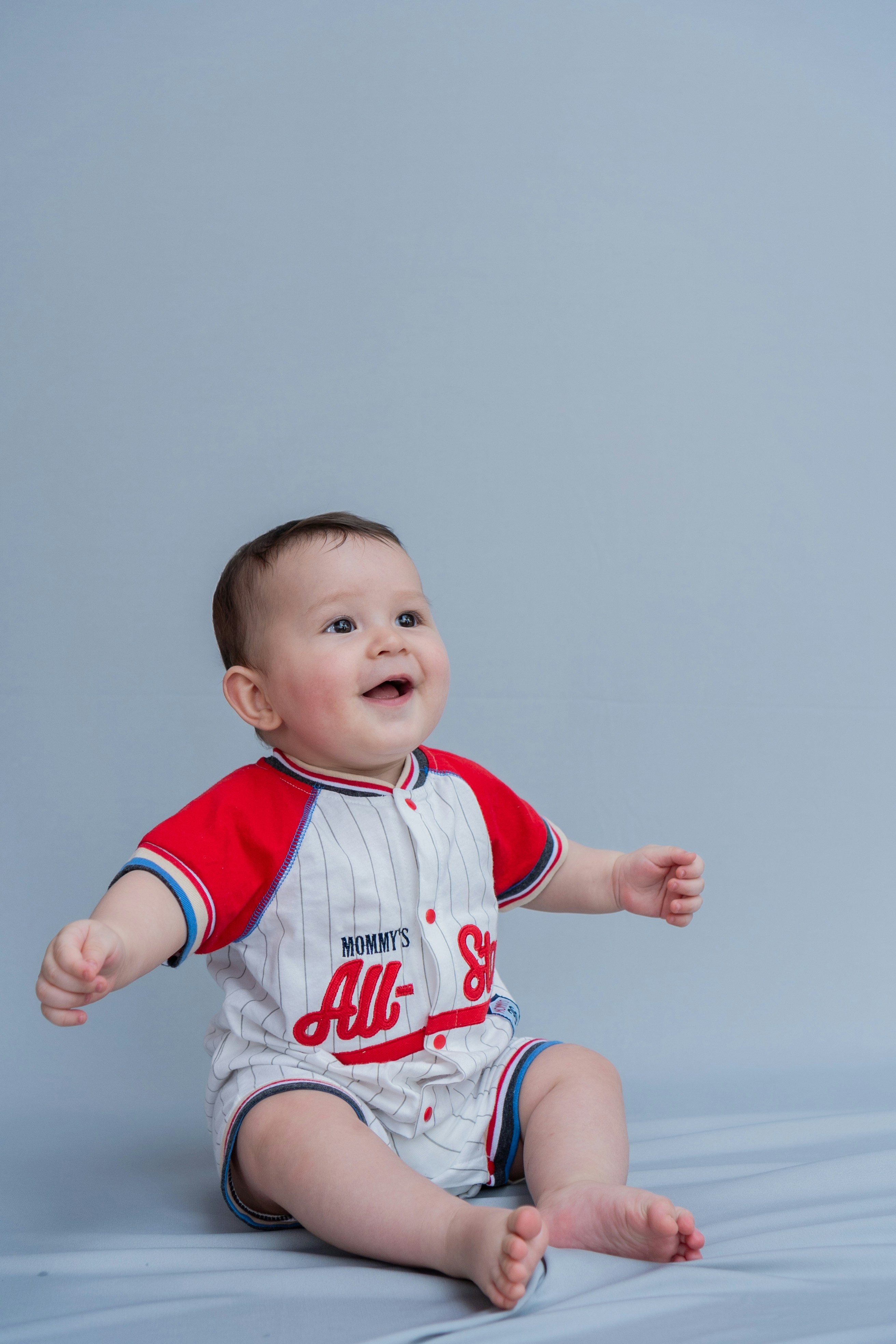 All-Star in the Making: giggles on a pastel blue backdrop
