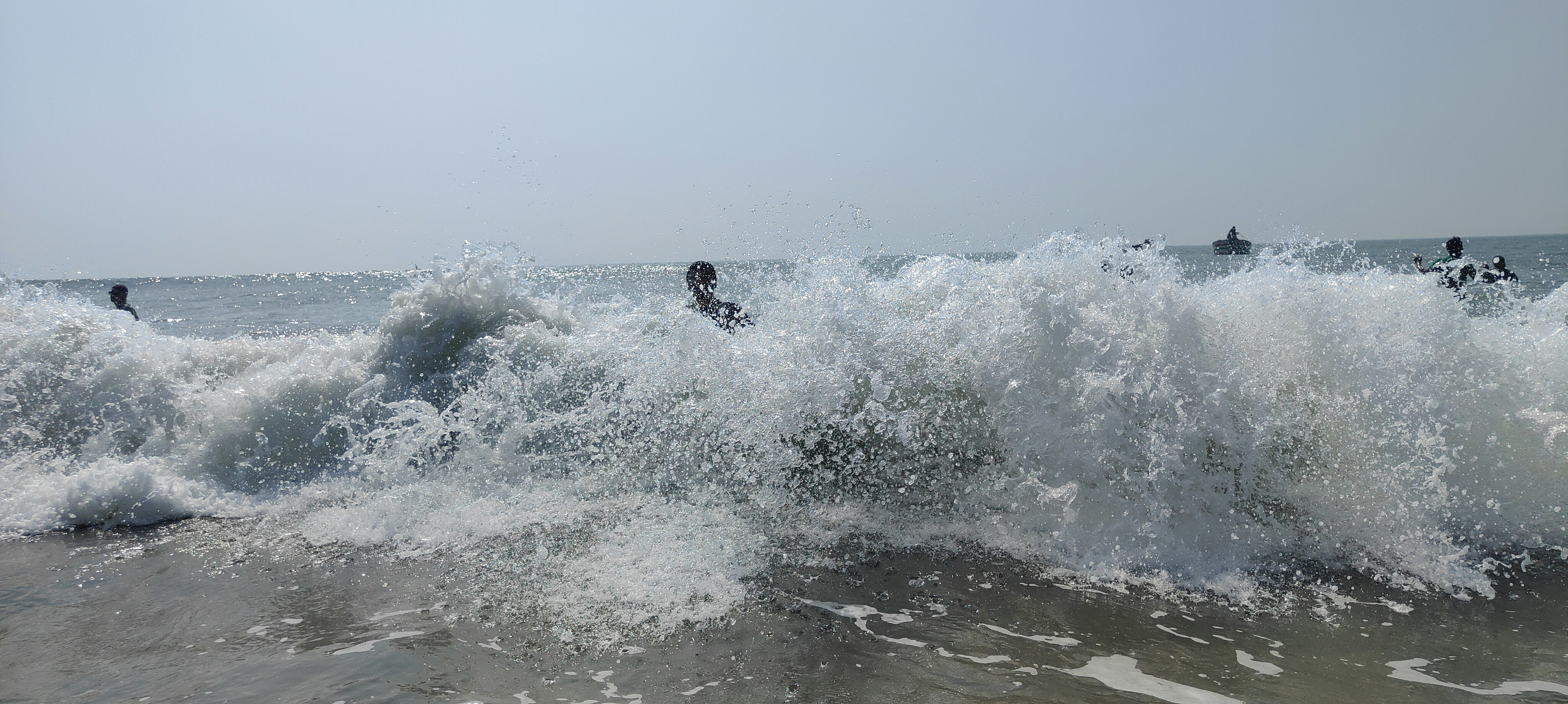 A group of people riding waves on top of surfboards photo – Free Sea ...