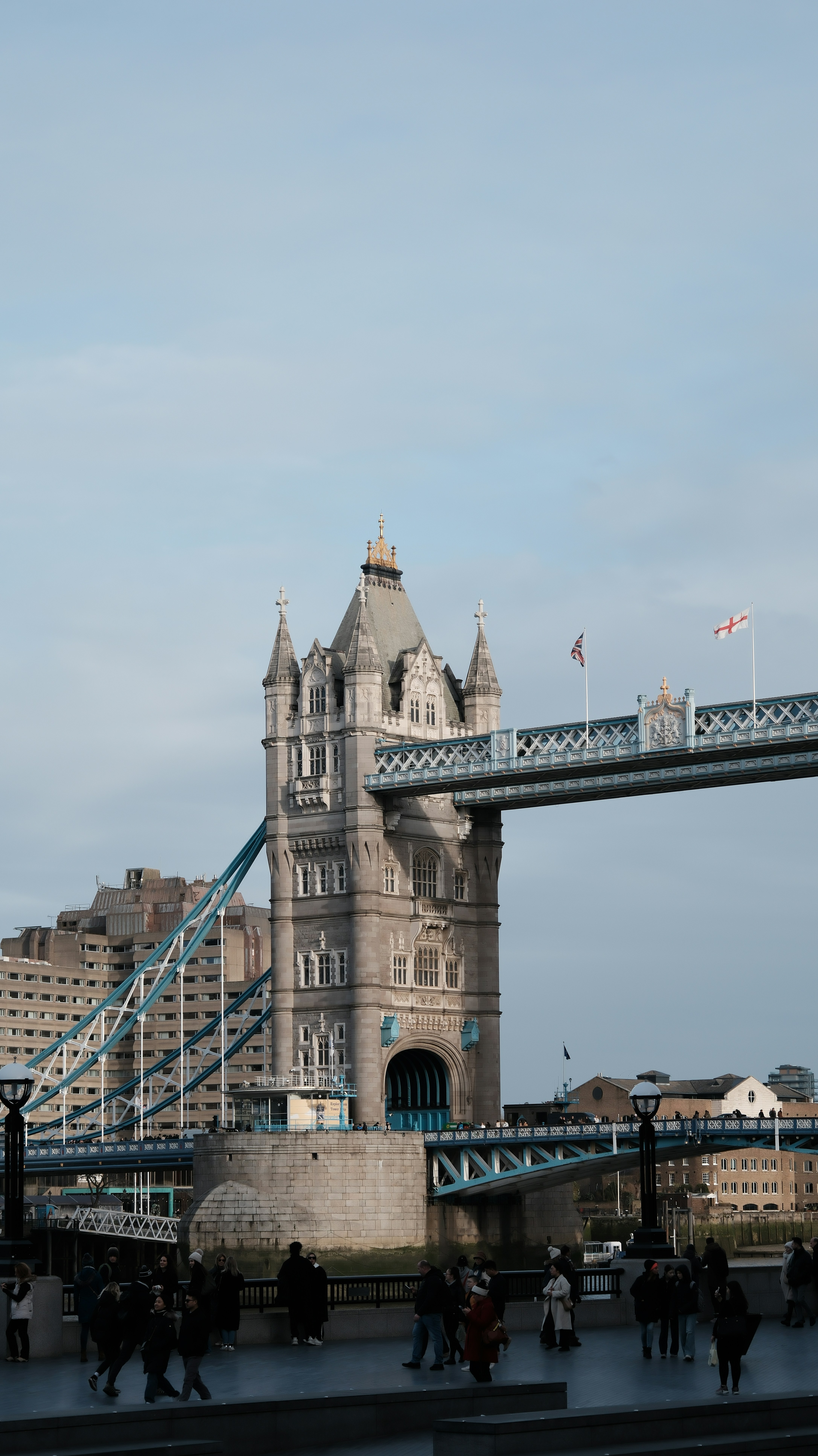 A group of people walking across a bridge
