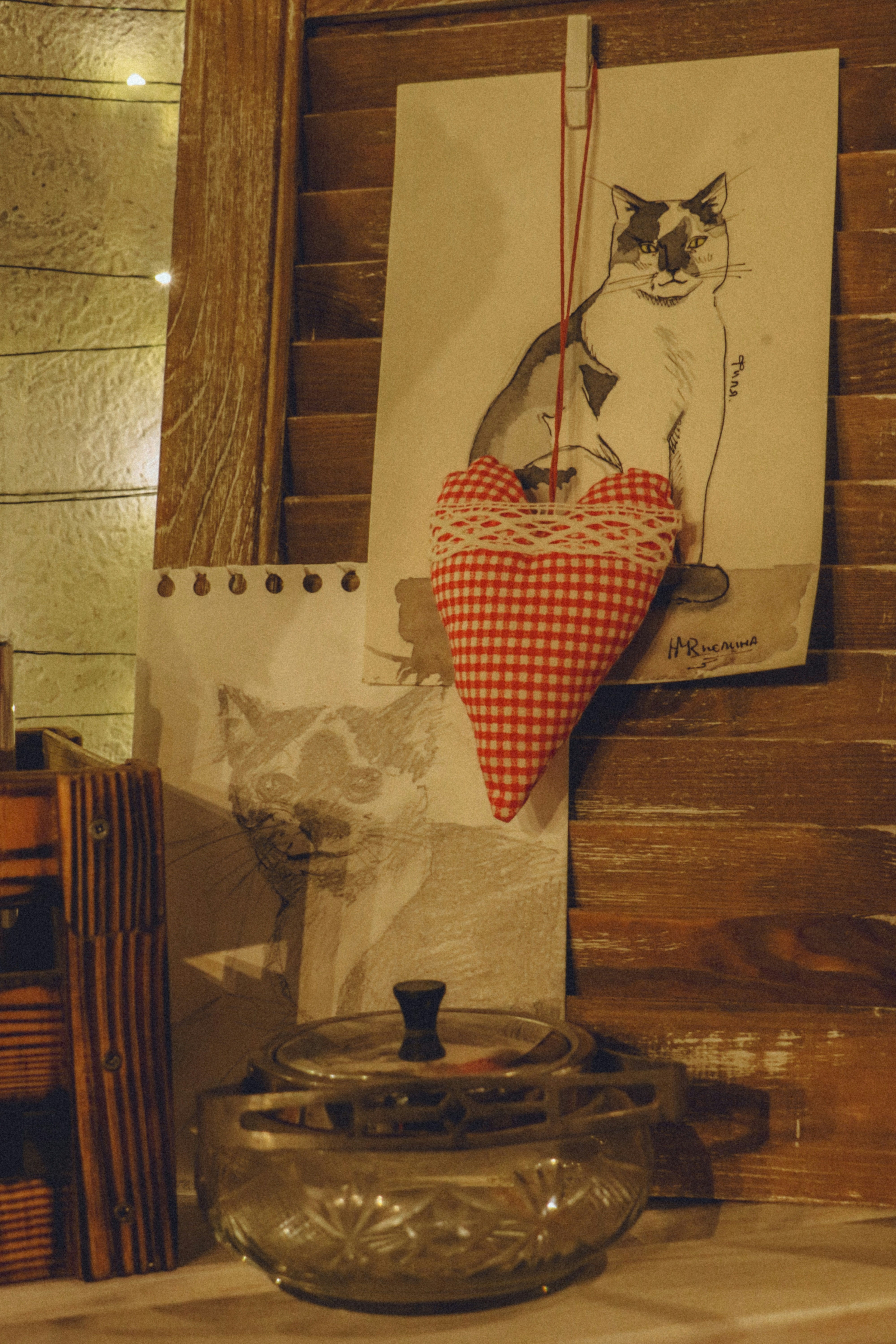 Heart on a String: A Cozy Gingham Accent Amid Cat Sketches