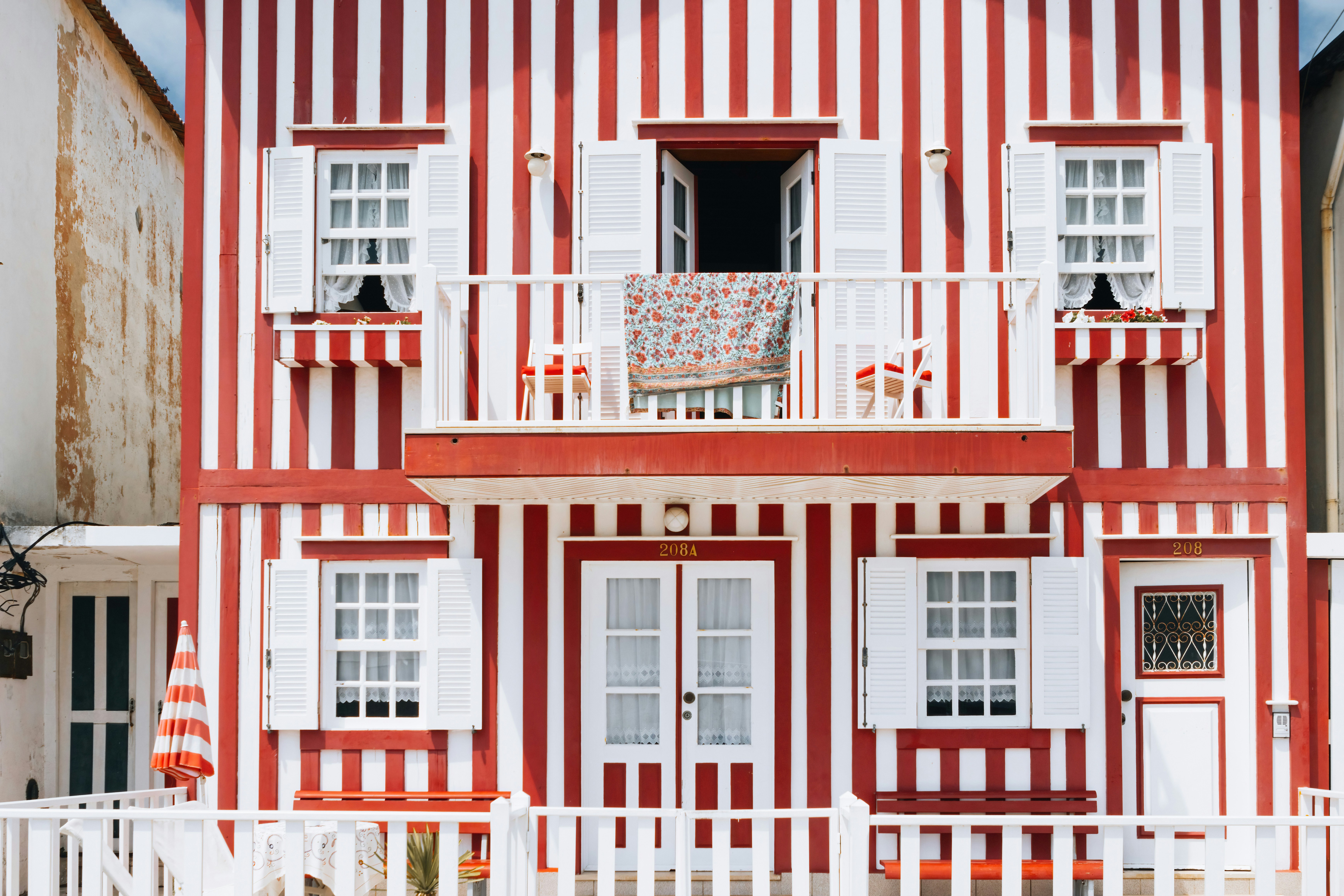 A red and white striped house with white shutters photo – Free Building ...