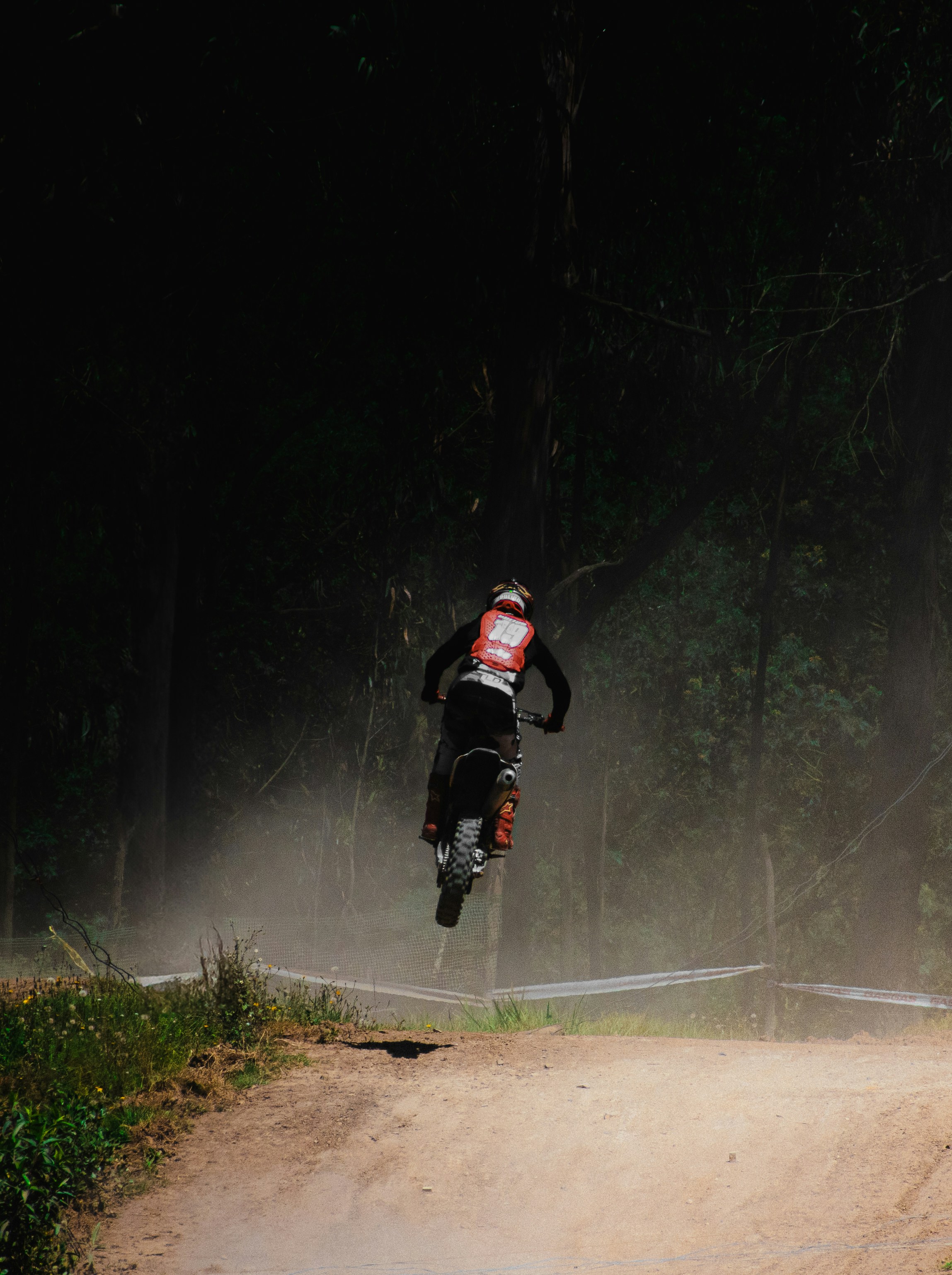 Mid-Air Dash: Rider Lifts Off into Dusty Track