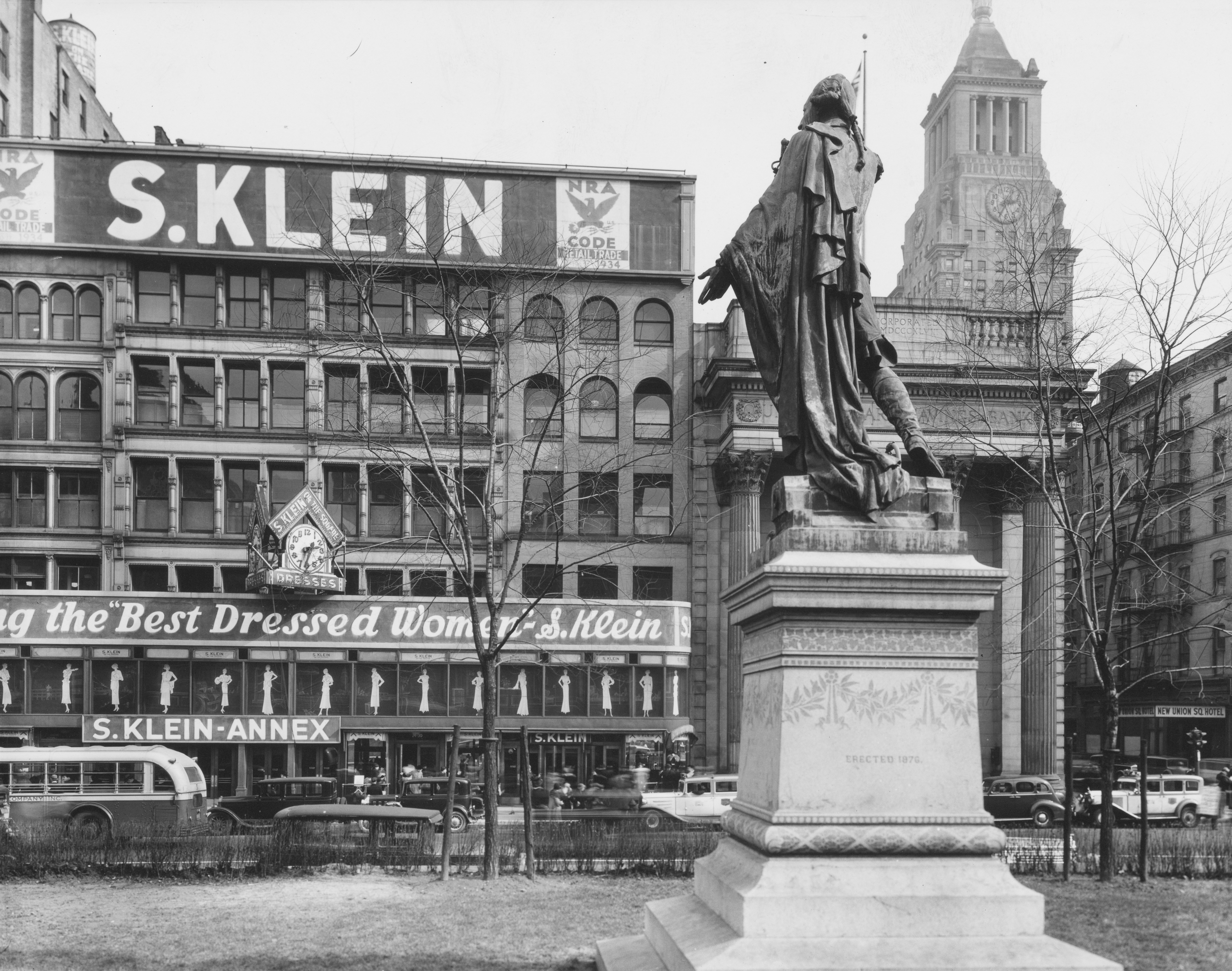 Statue Overlooking a Historic Storefront: The S. Klein Cornerstone in Monochrome