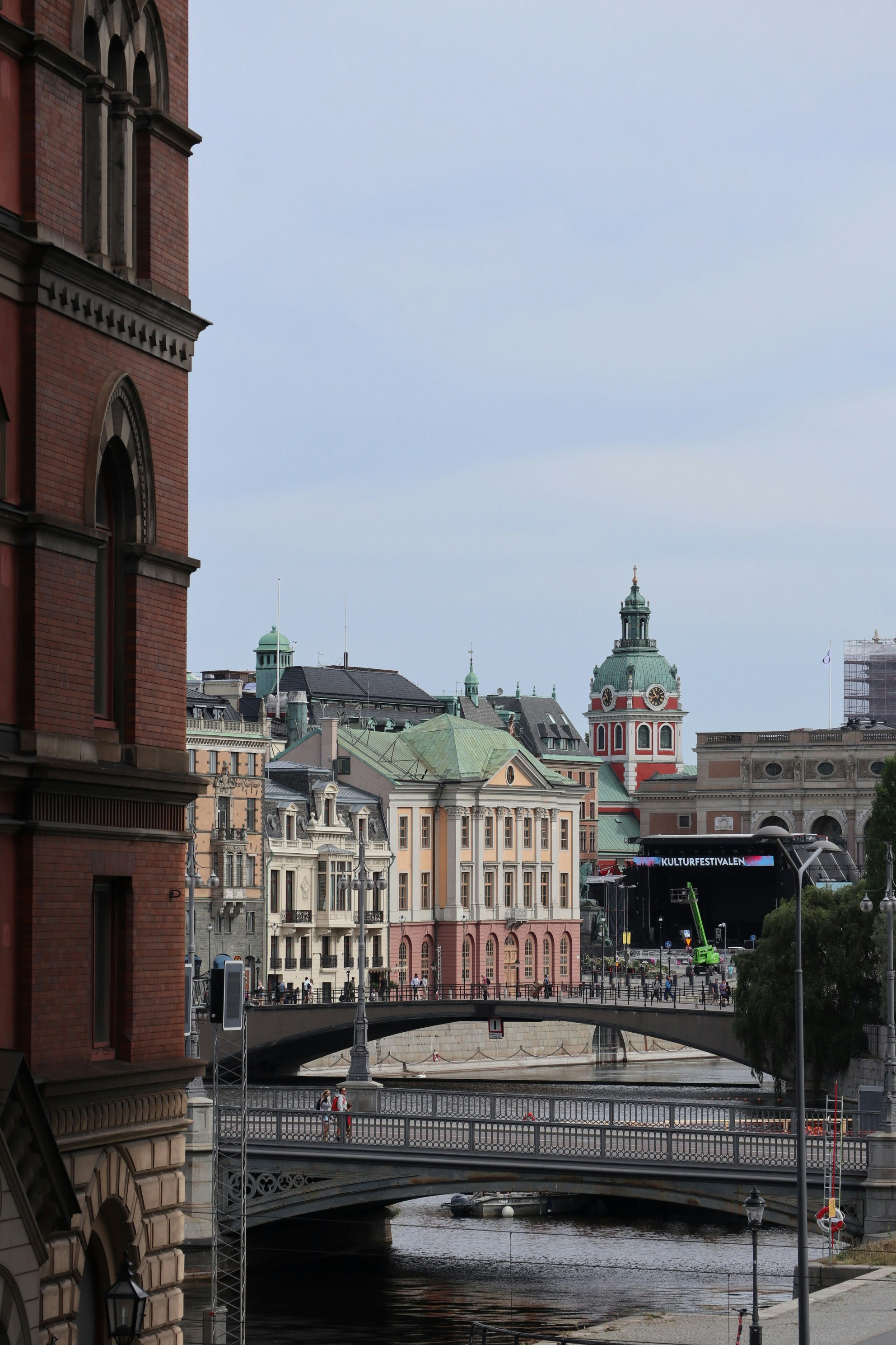 A bridge crossing over a river next to tall buildings photo – Free ...