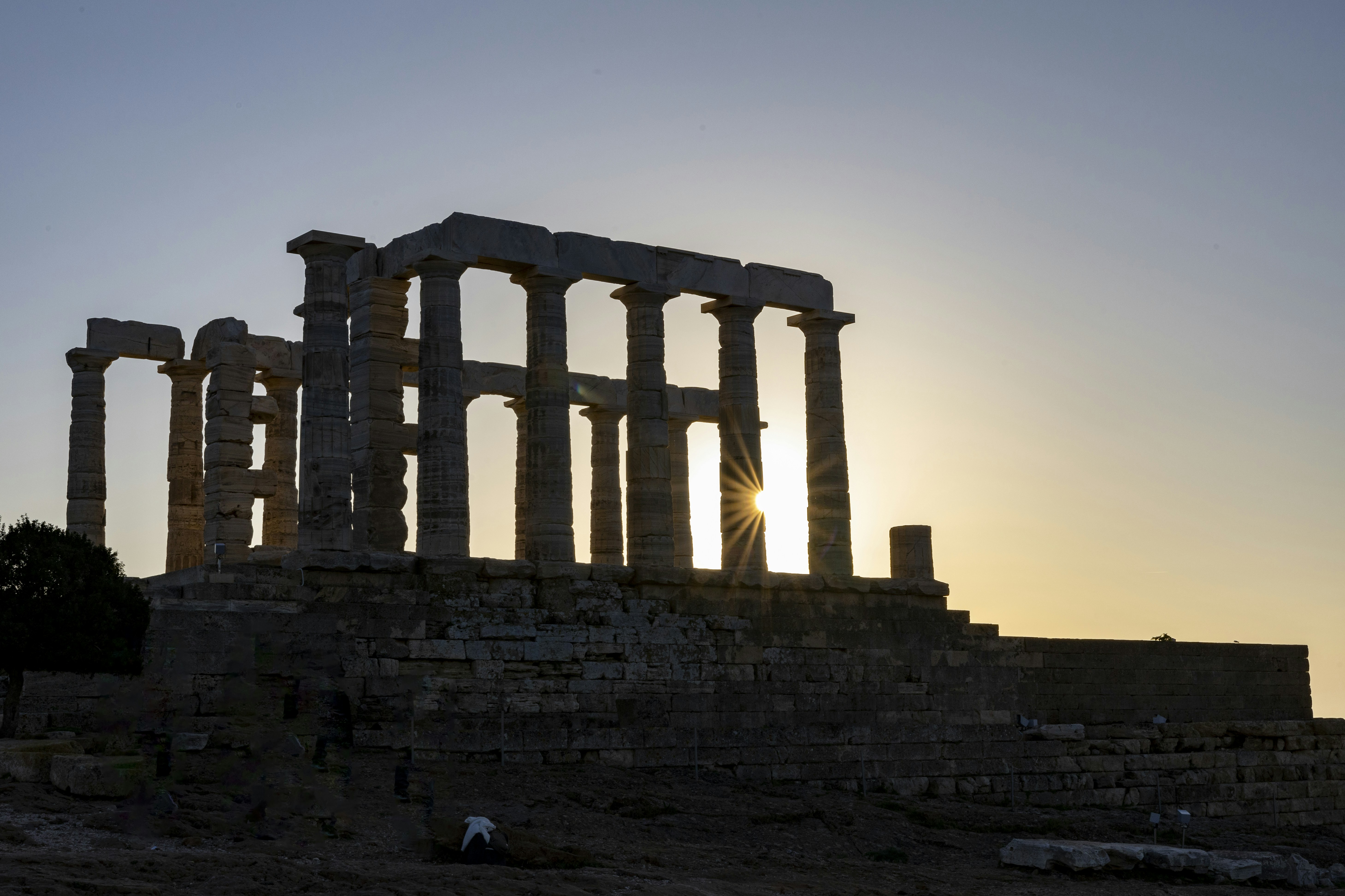 The sun is setting behind the ruins of a building photo – Free Temple ...