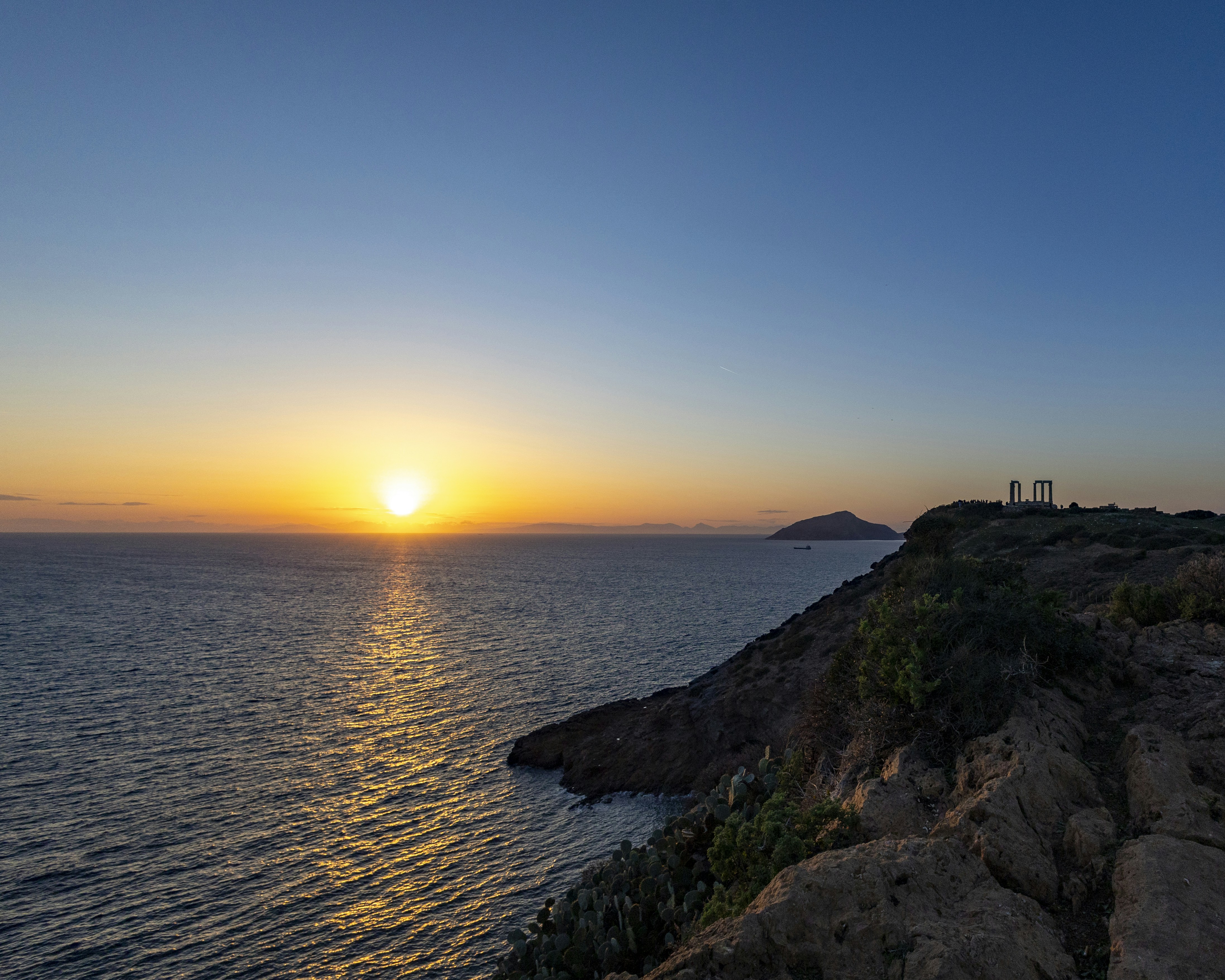 Amber Crest Over Quiet Seas: A Cliffside Dusk