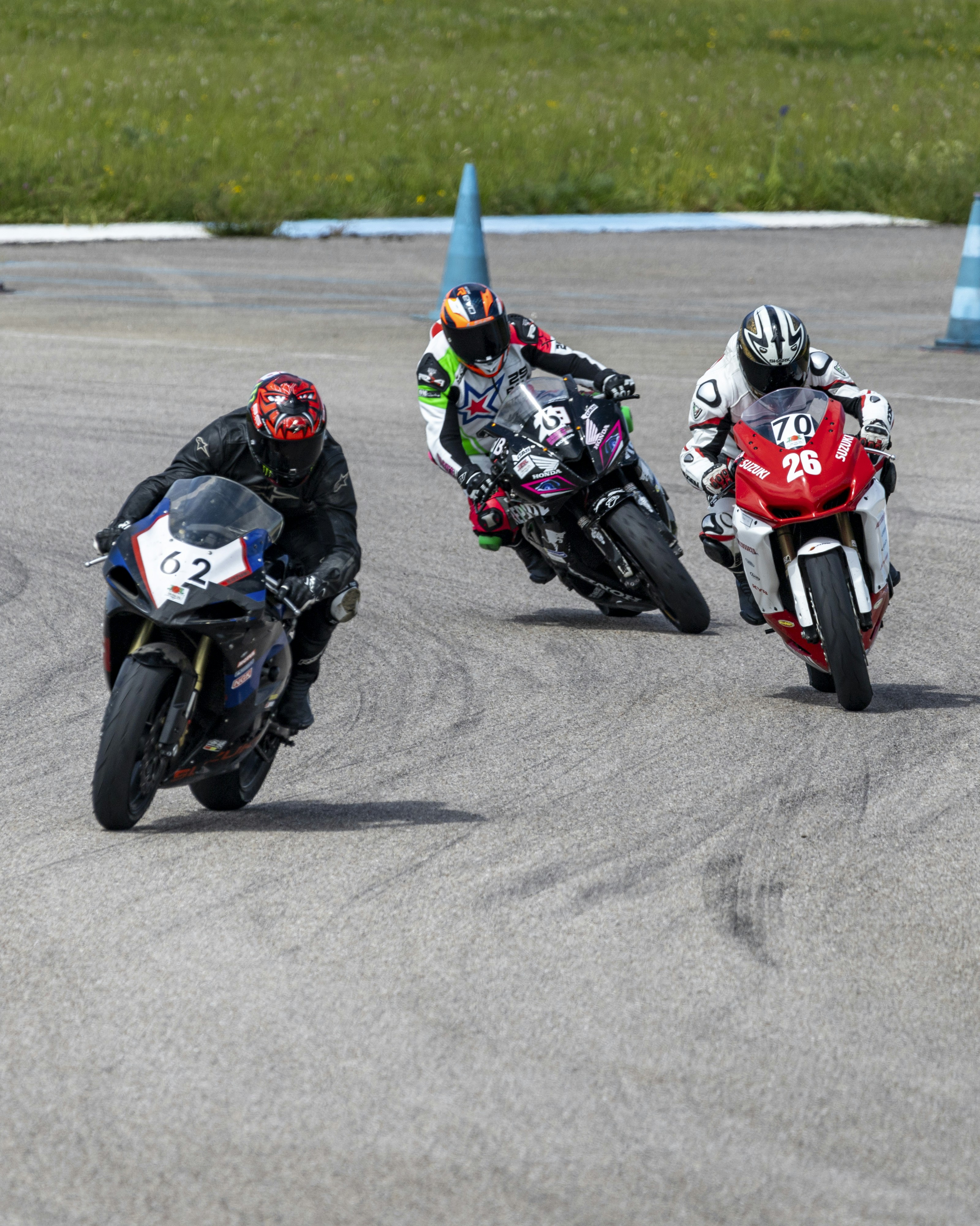 A group of motorcyclists racing around a track photo – Free Circuit de ...