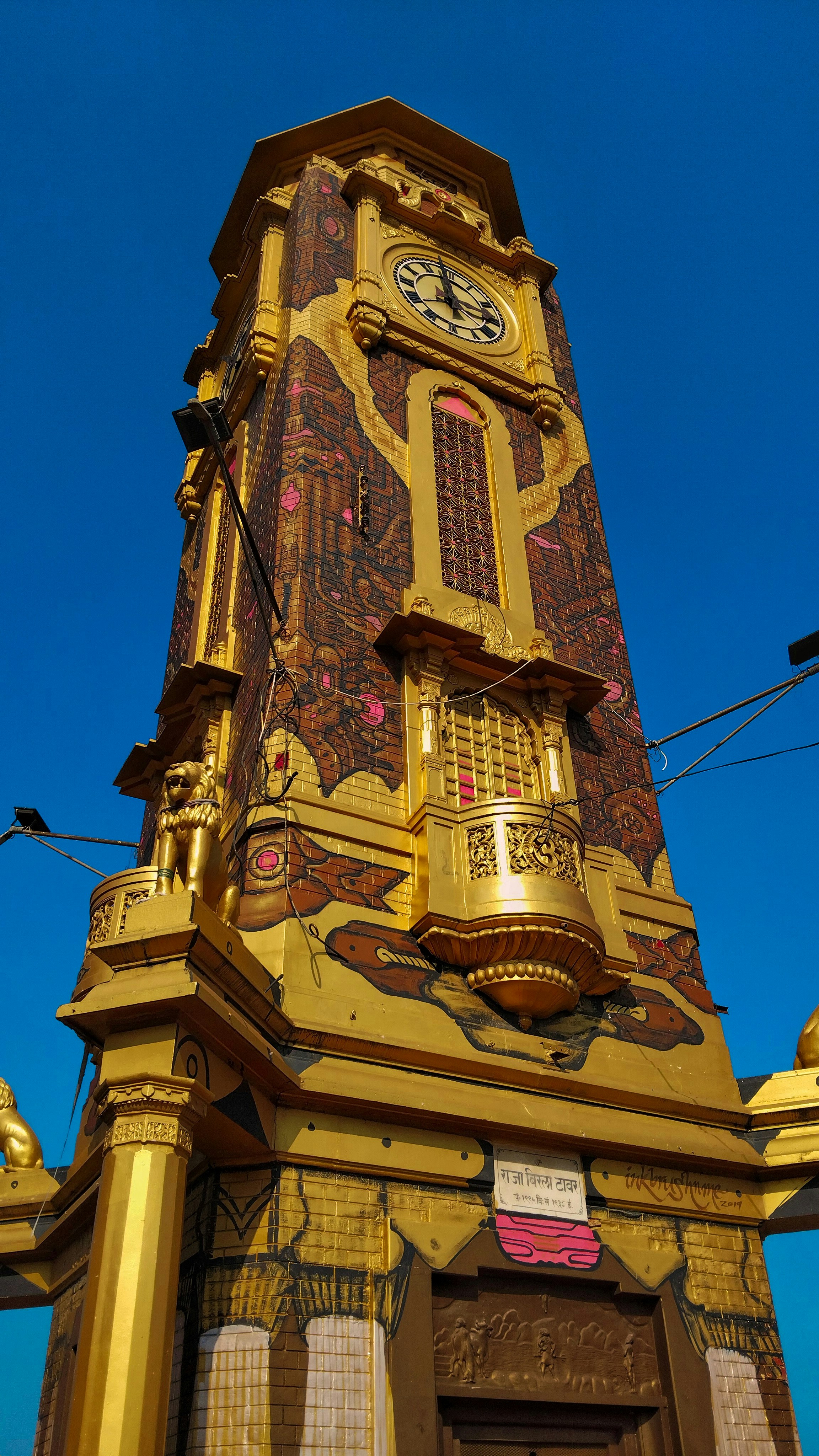 Golden Clock Tower Ascends Against a Cerulean Sky