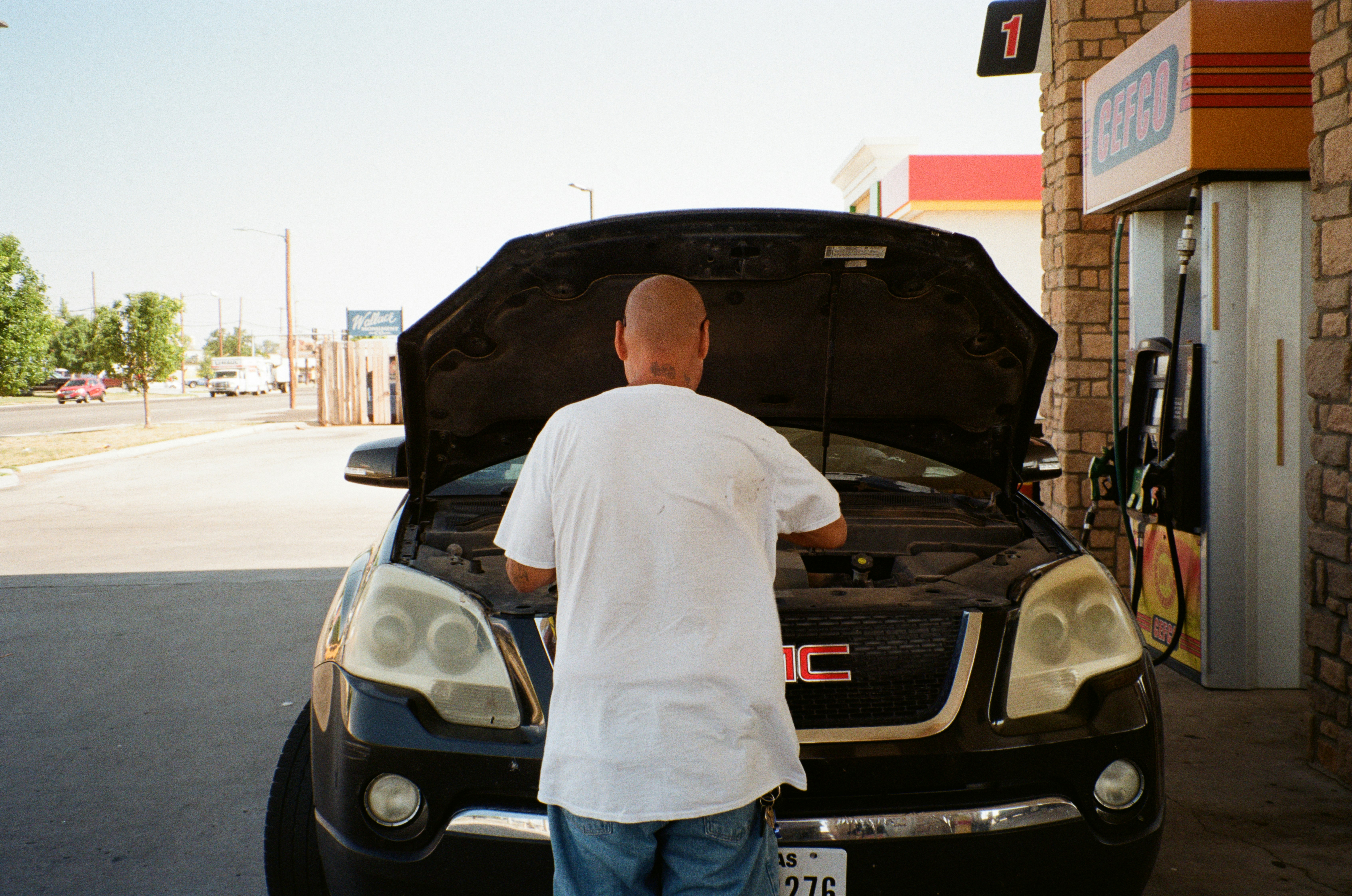 A man standing next to a car with its hood open photo – Free Analogue ...