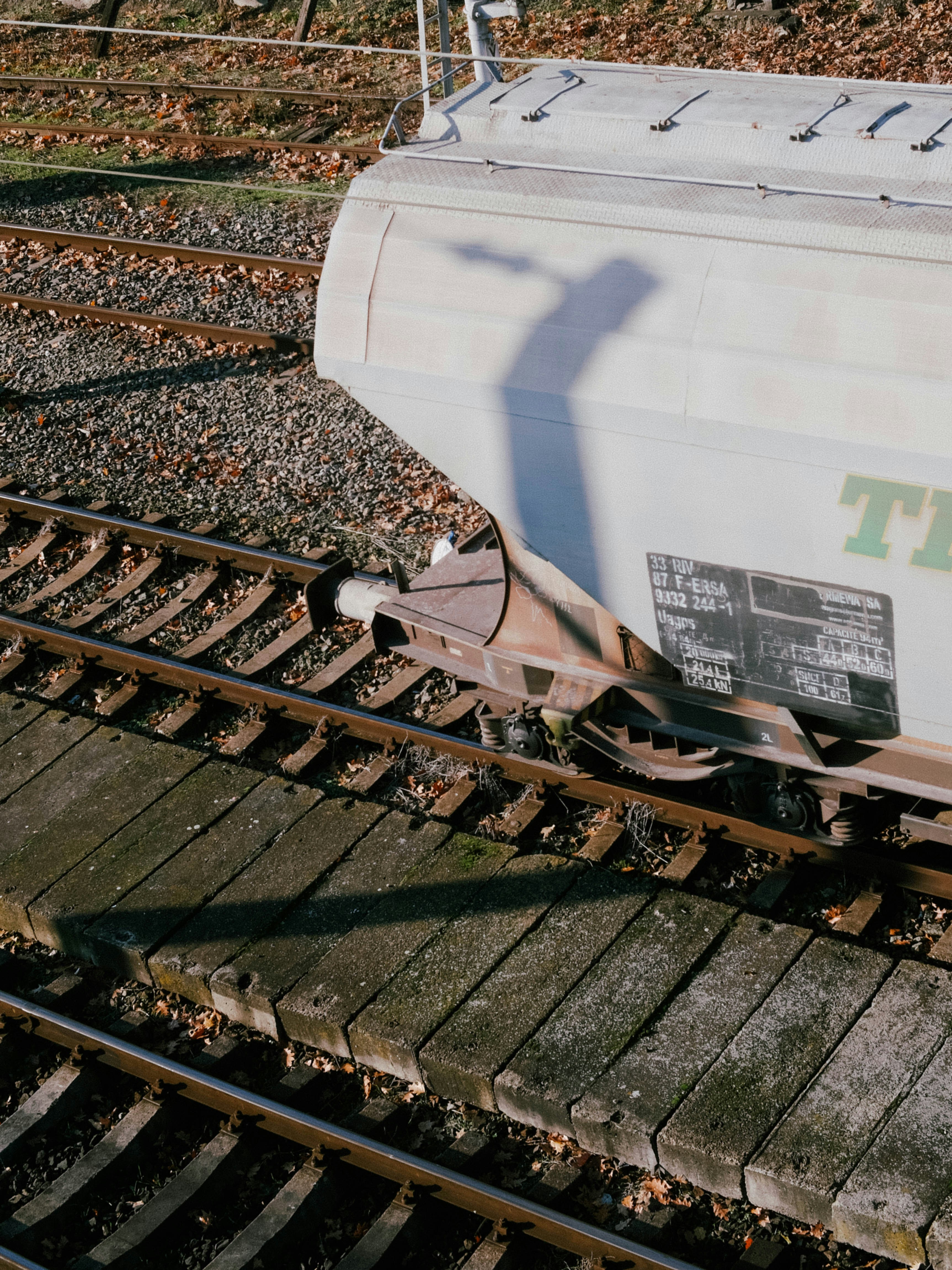 A white train car sitting on top of train tracks photo – Free Train ...