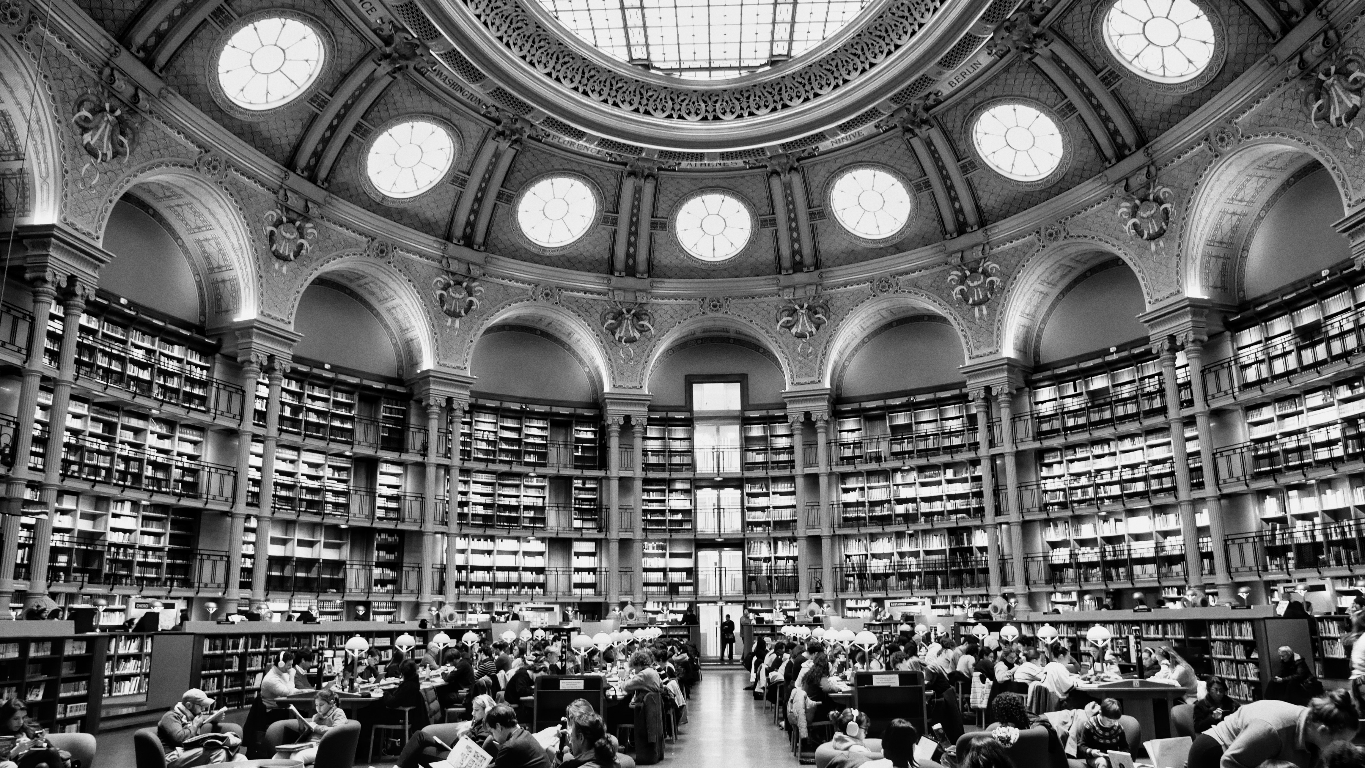 A large library filled with lots of books photo – Free Man Image on ...