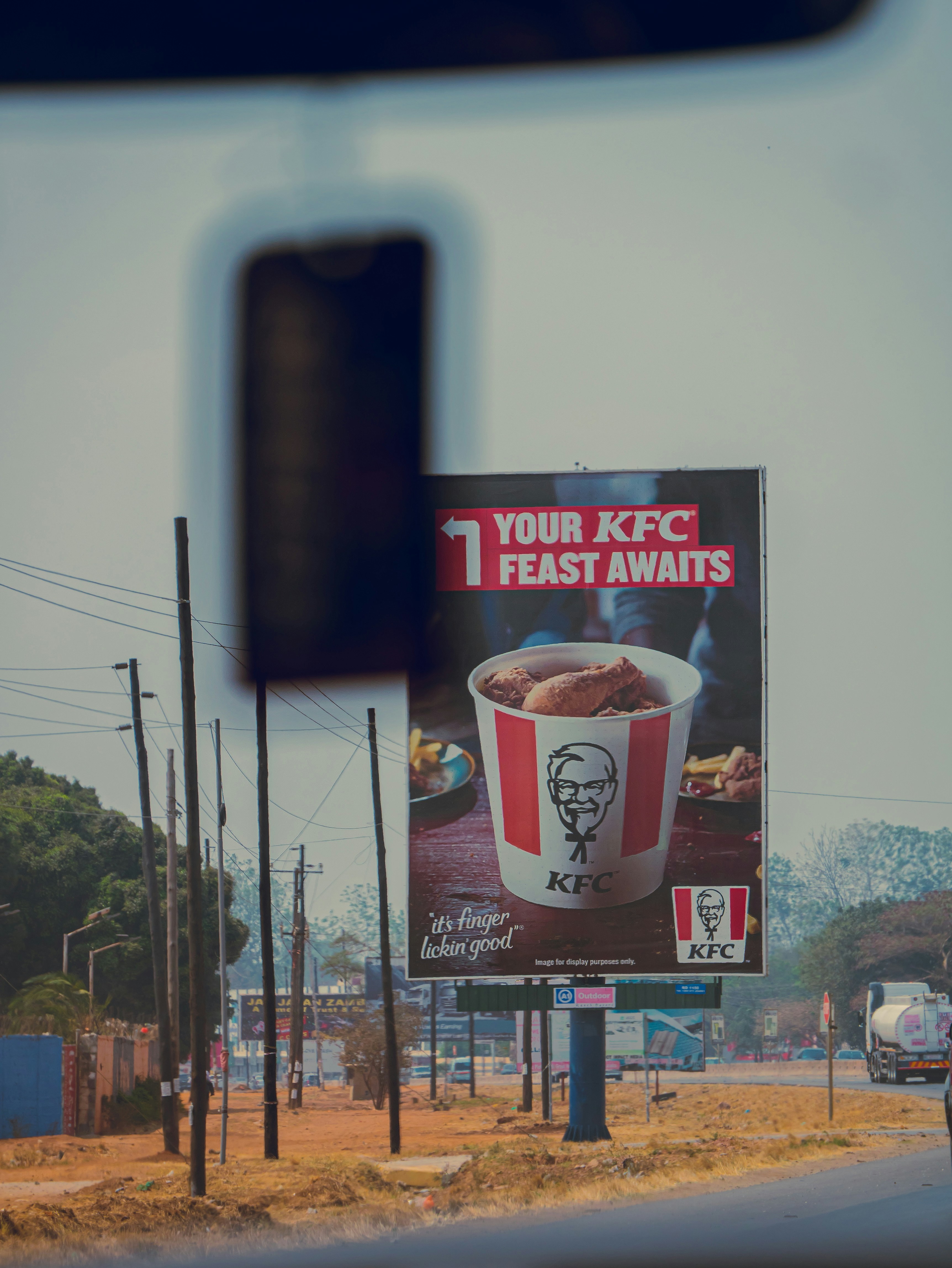 A billboard on the side of the road advertising fast food photo – Free ...