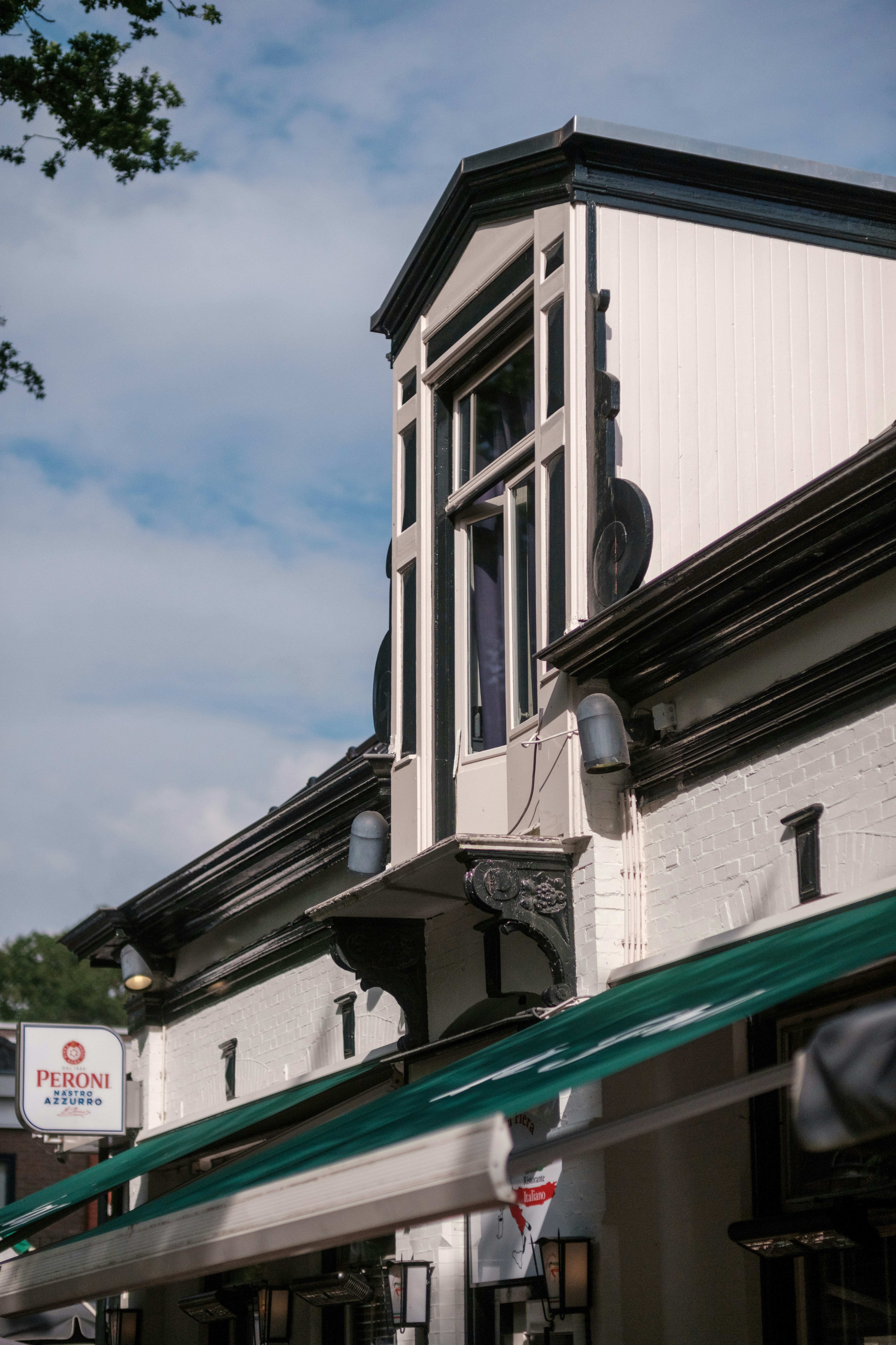 Architectural Tilt: Cornice and Window Details on a Tea-Kit Streetfront