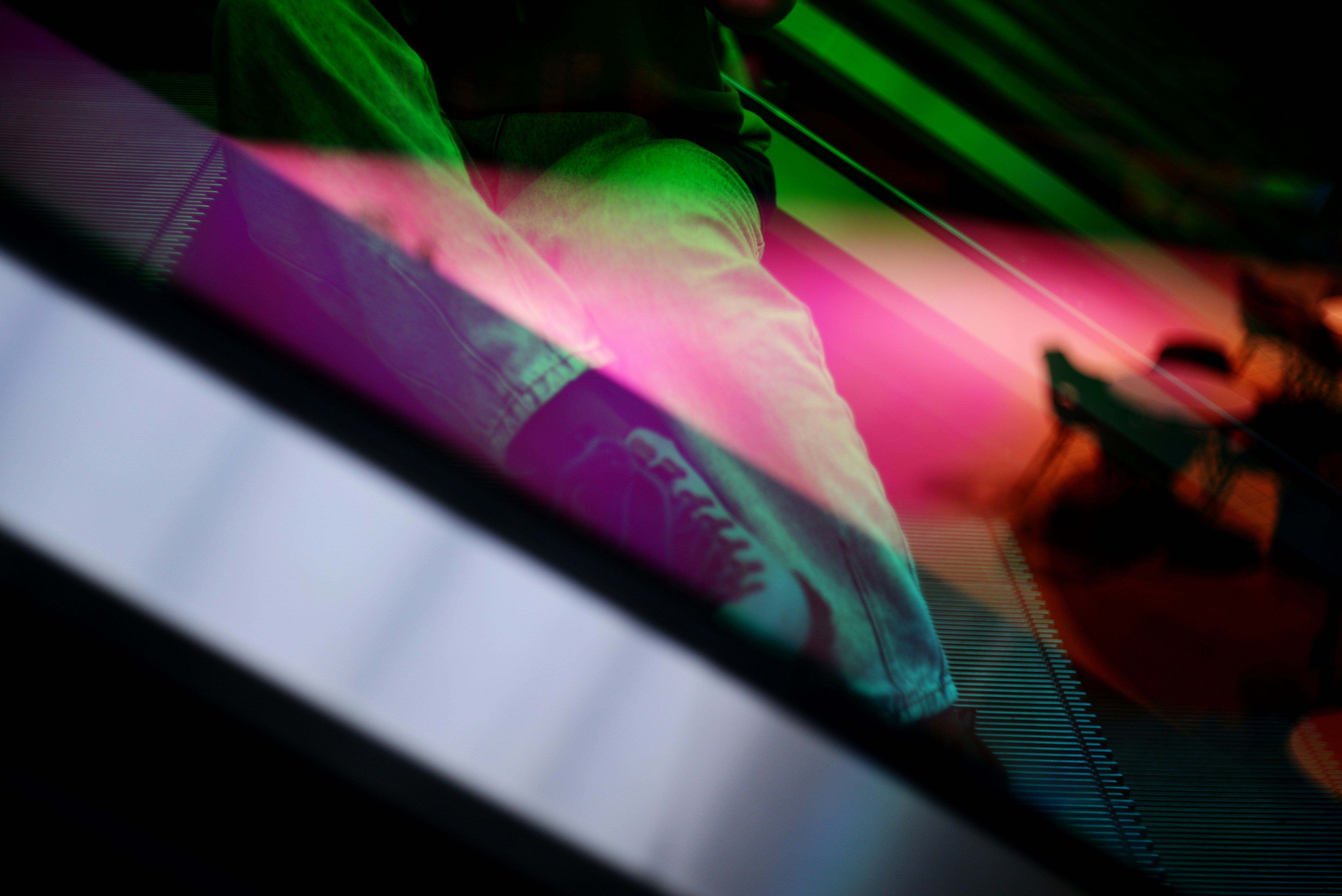 A blurry photo of a person standing in front of a TV