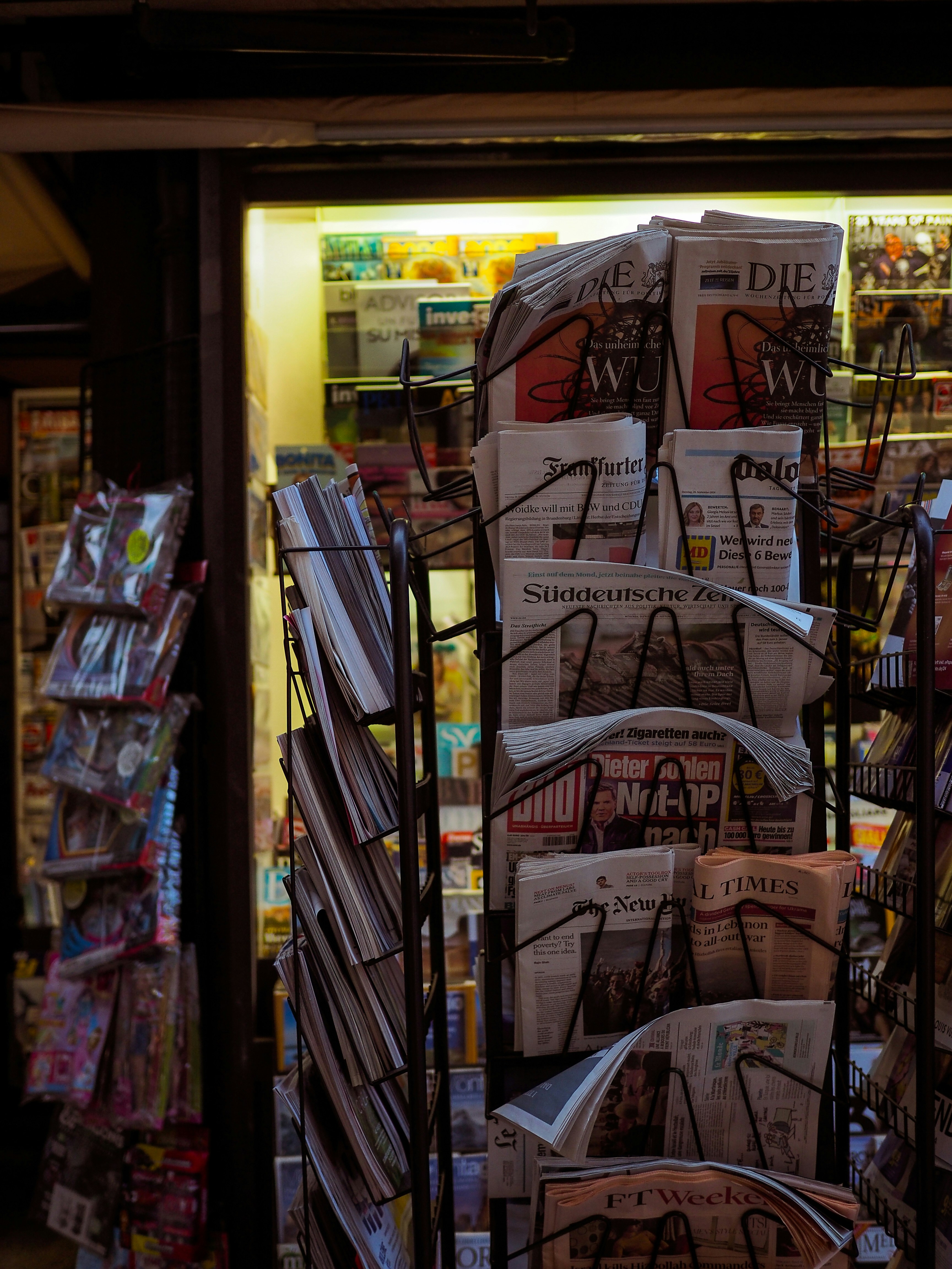 A display of newspapers in a store window photo – Free Verona Image on ...