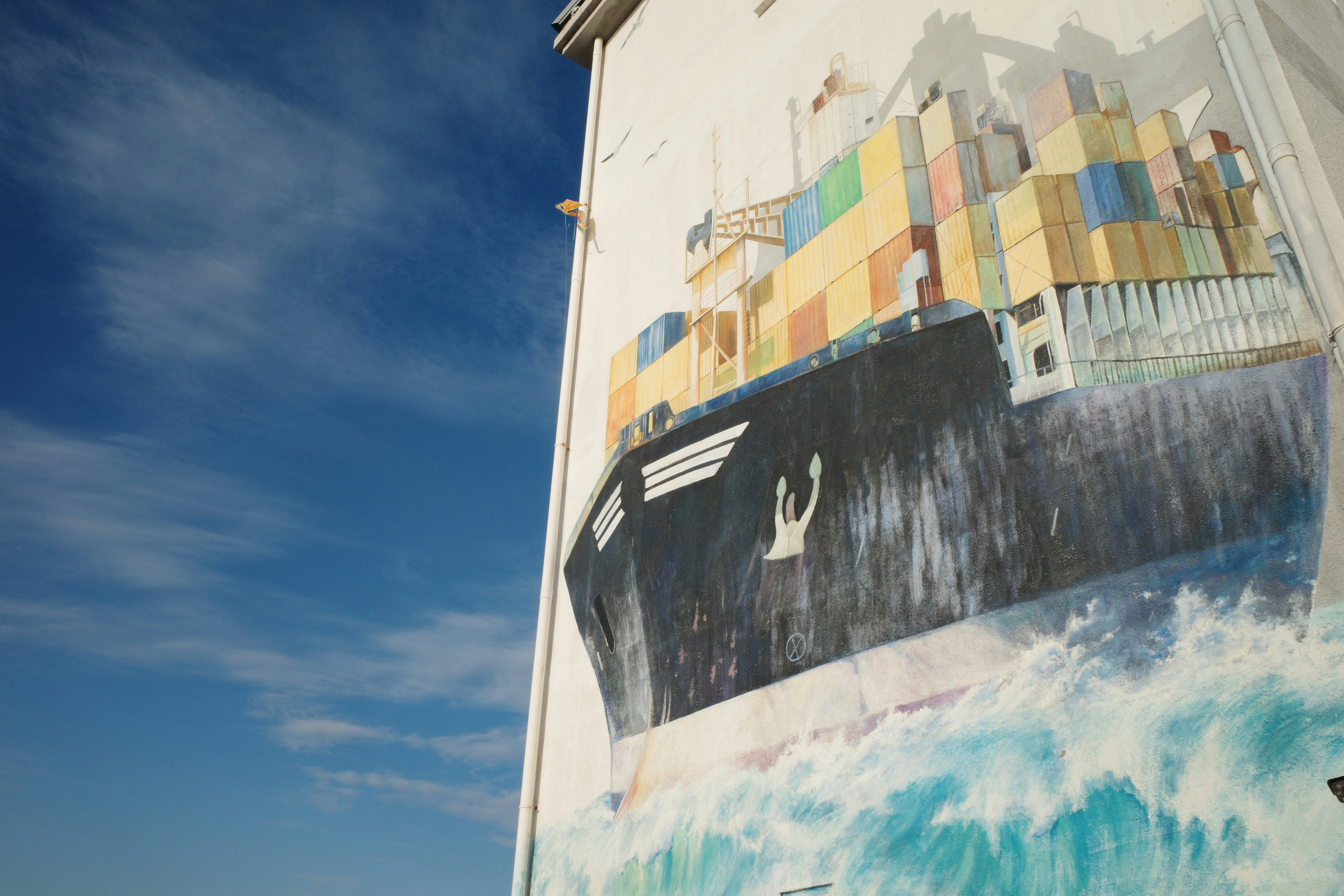 Buoyant Canvas: Container Ship Mural Anchored on a Sunlit Wall