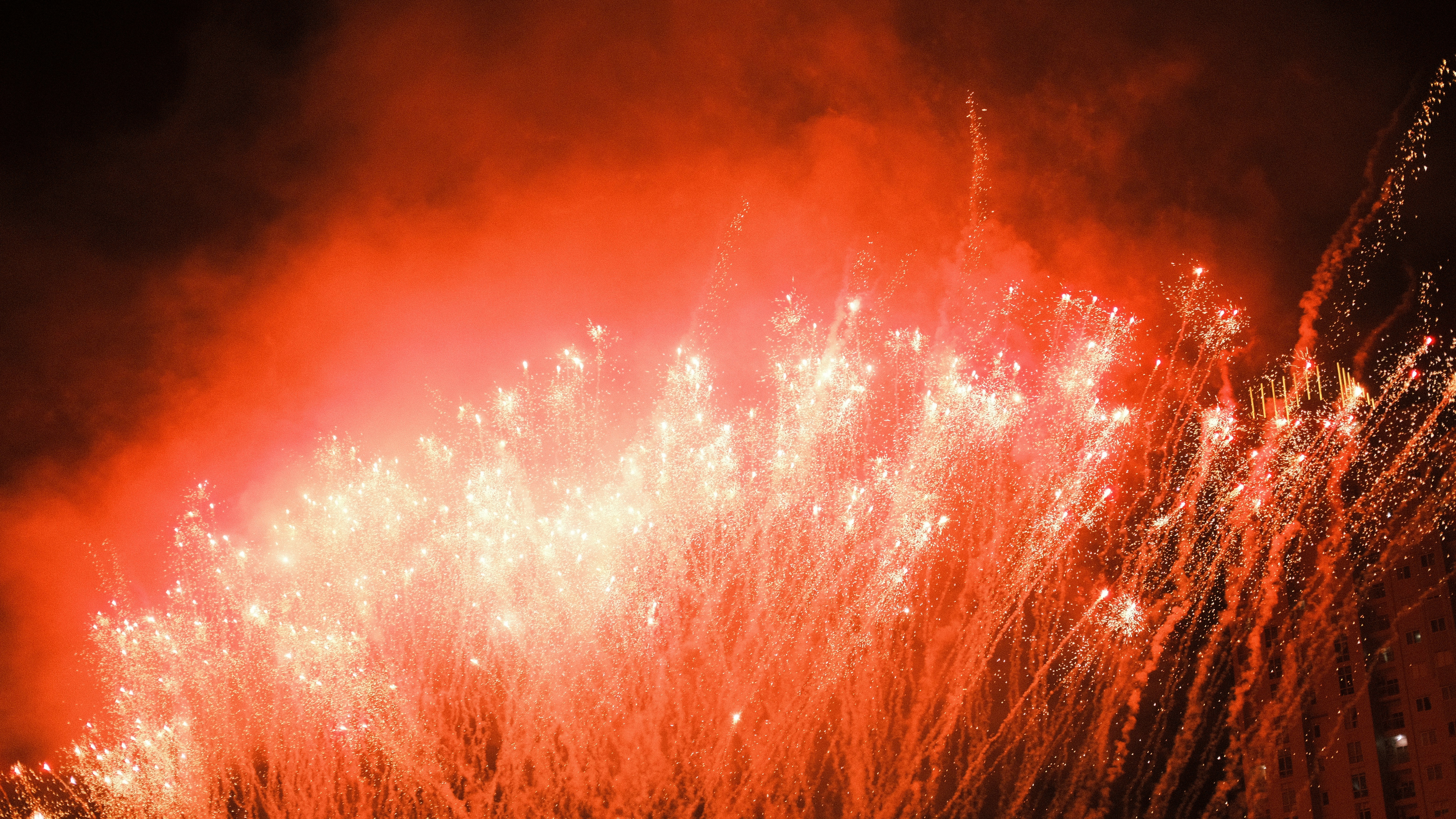 A red fireworks is lit up in the night sky photo – Free Night Image on ...