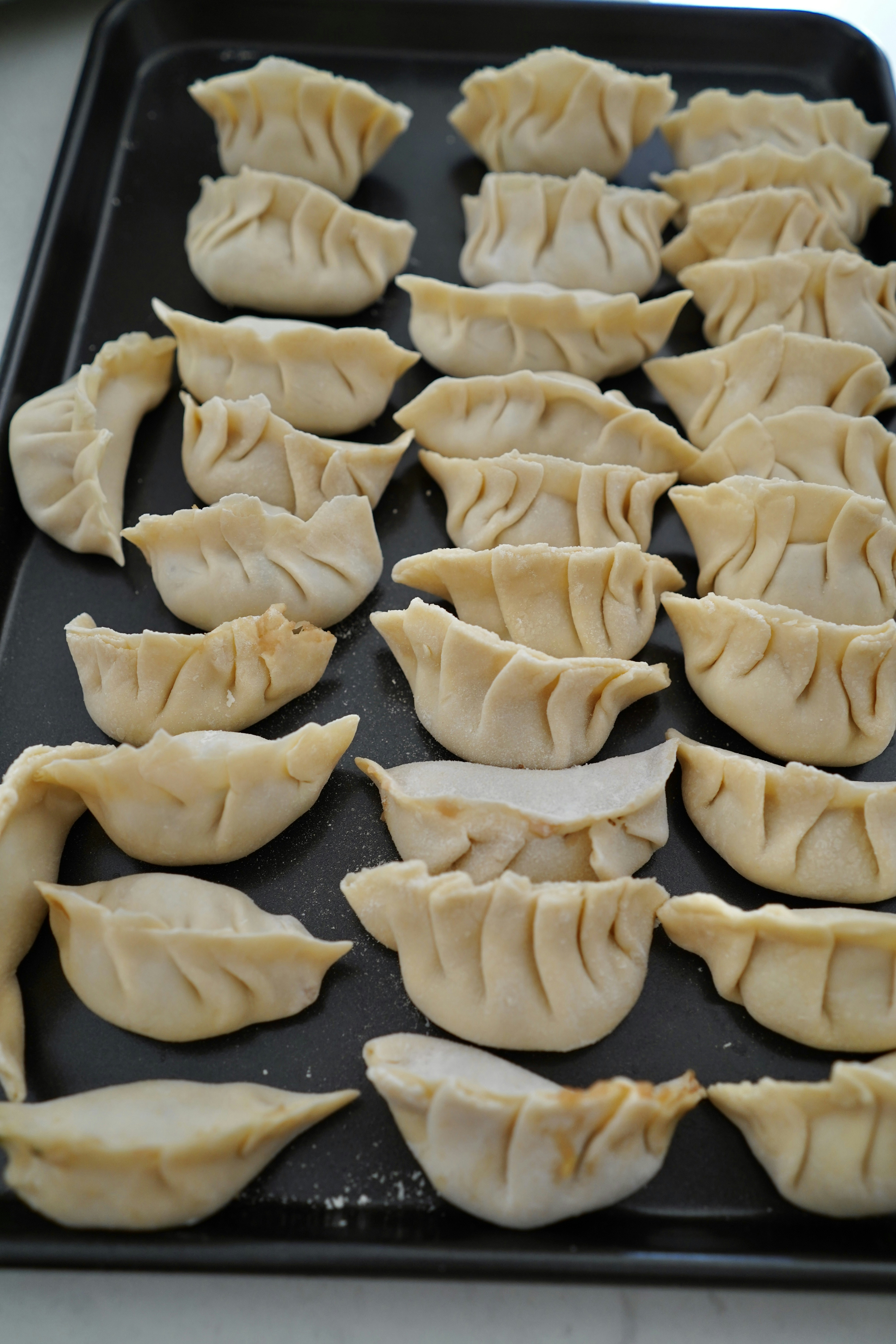 A tray filled with dumplings on top of a table photo – Free Food Image ...