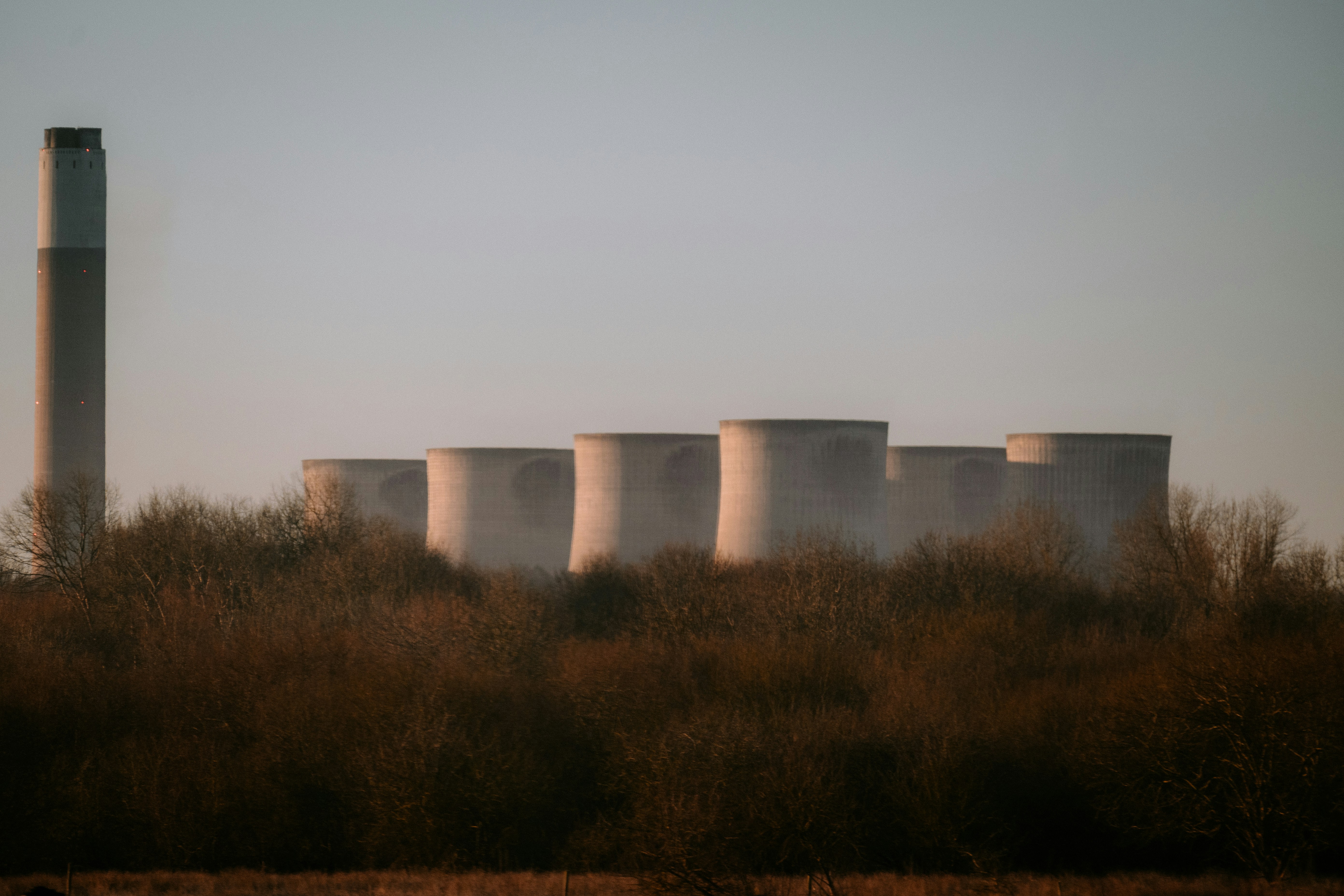 A factory with smoke stacks in the background photo – Free Building ...