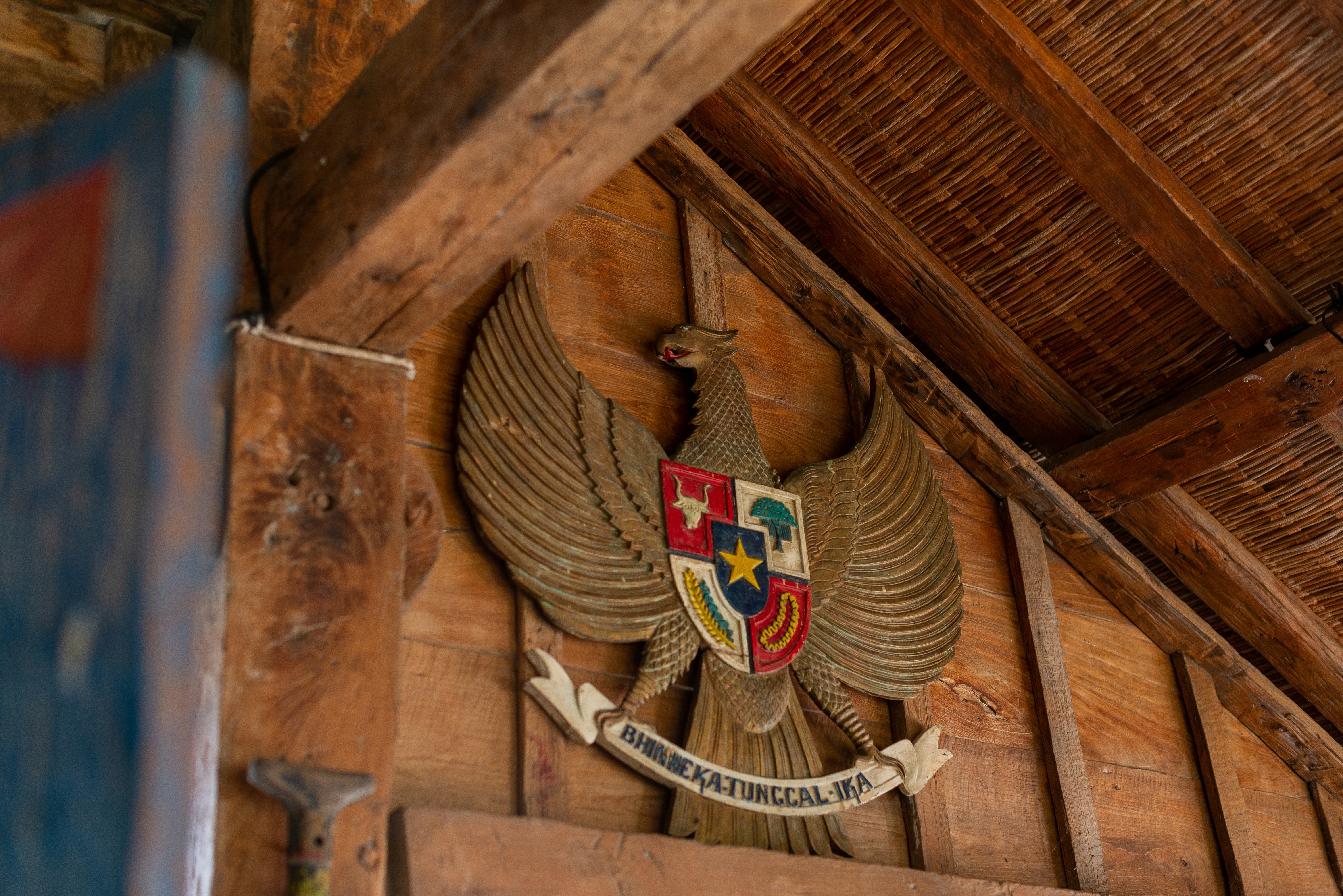 Garuda Crest in a Timber Hall: An Emblem Amid Rustic Beams