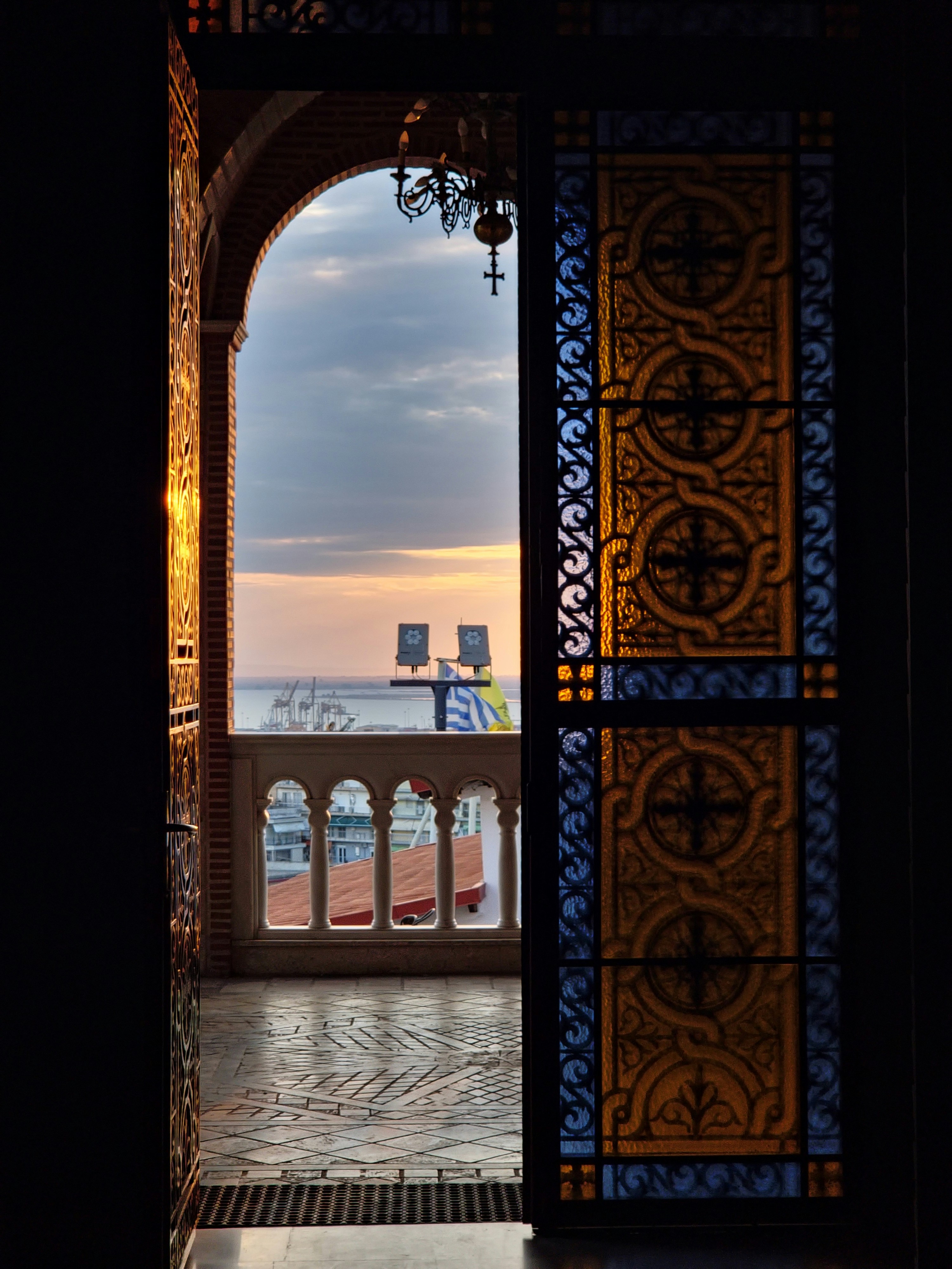 Sunset Through the Moorish Gate: Amber Ironwork Framing a Sea Horizon