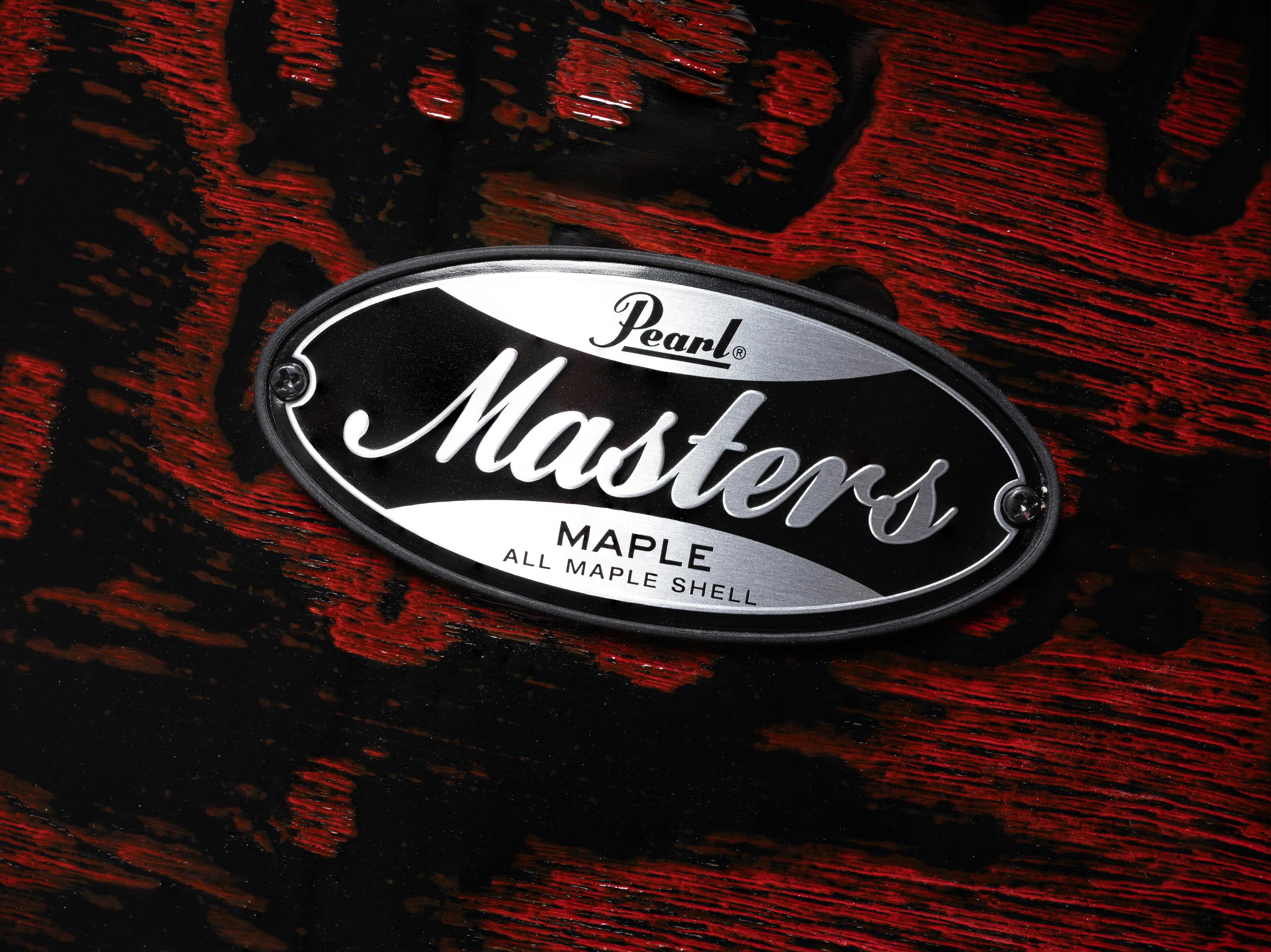 Close-up of a Pearl Masters drum badge highlighting its all maple shell construction.