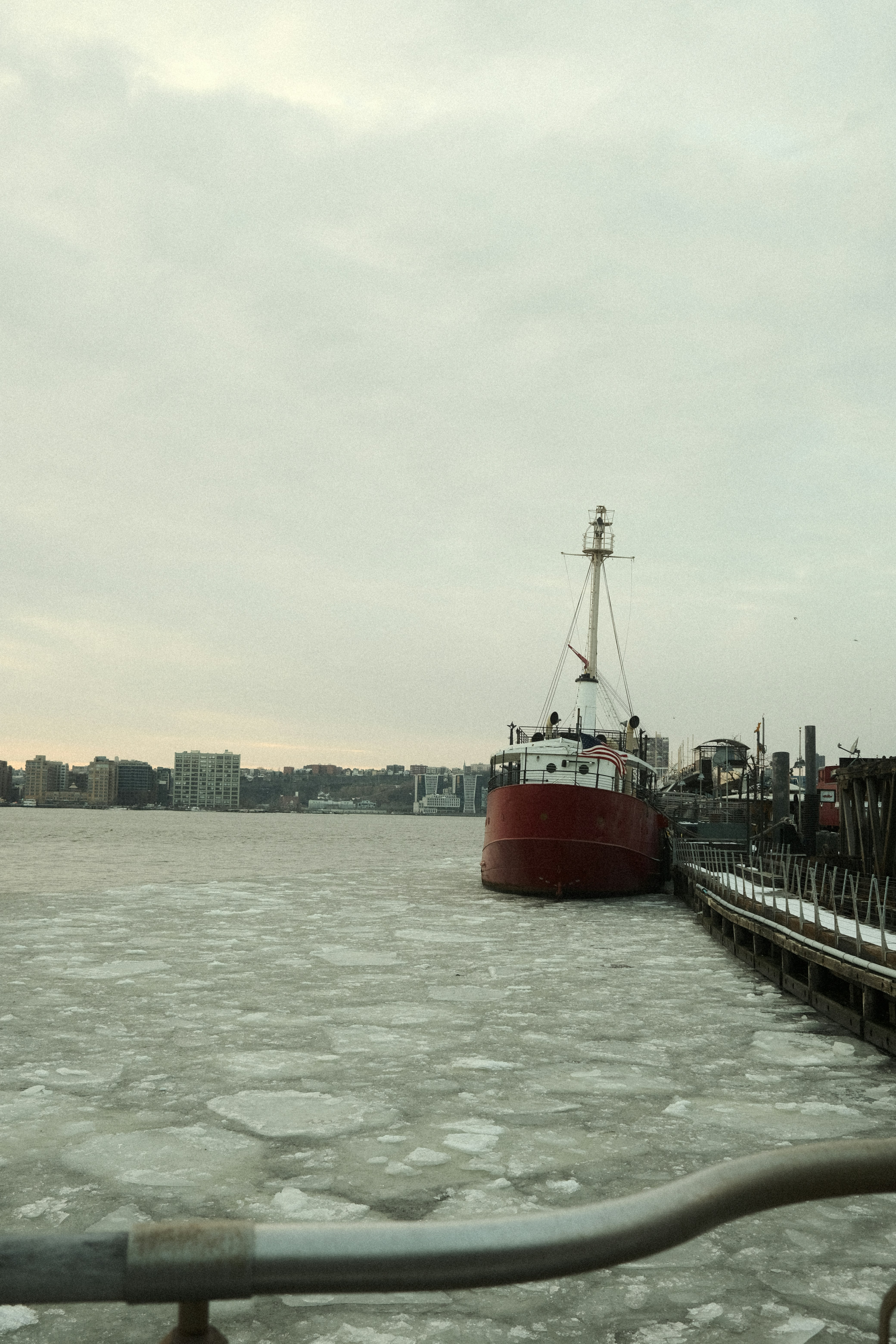 Red-Hulled Vessel Quietly Moored on a Frozen Harbor