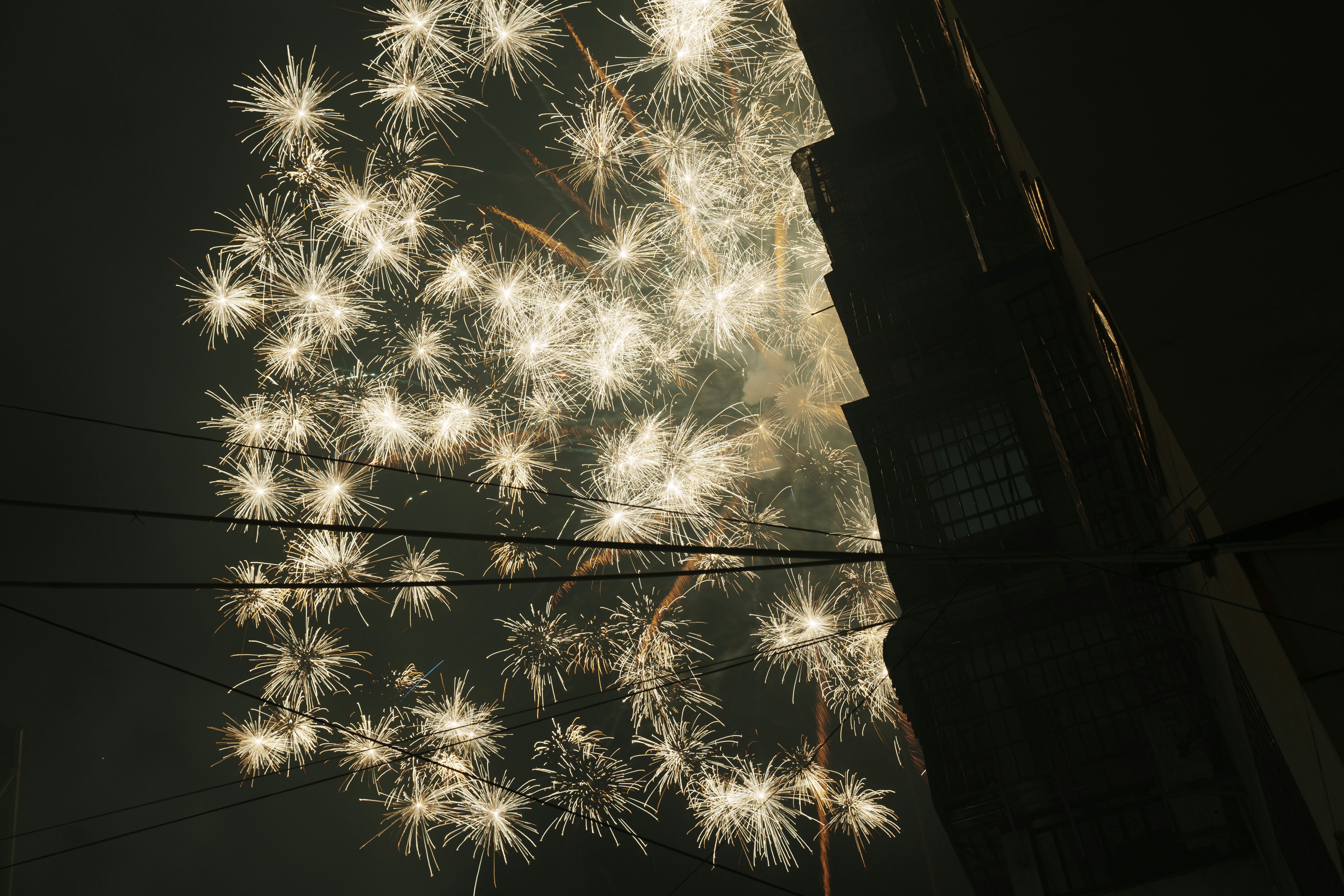 Crown of Sparks Over a Quiet Facade