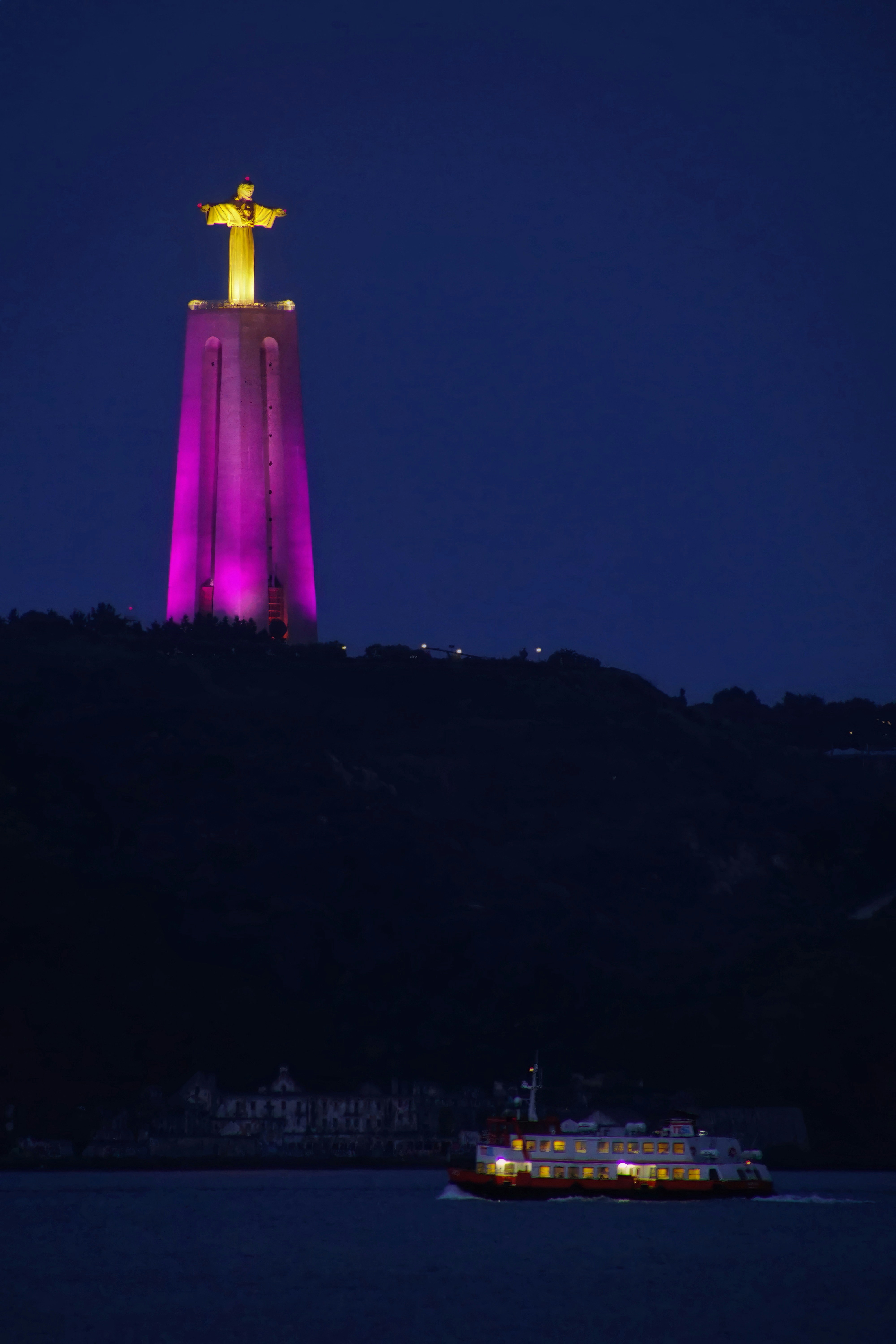 Purple Beacon on the Hill: A Night-Illuminated Monument Overlooking the Harbor