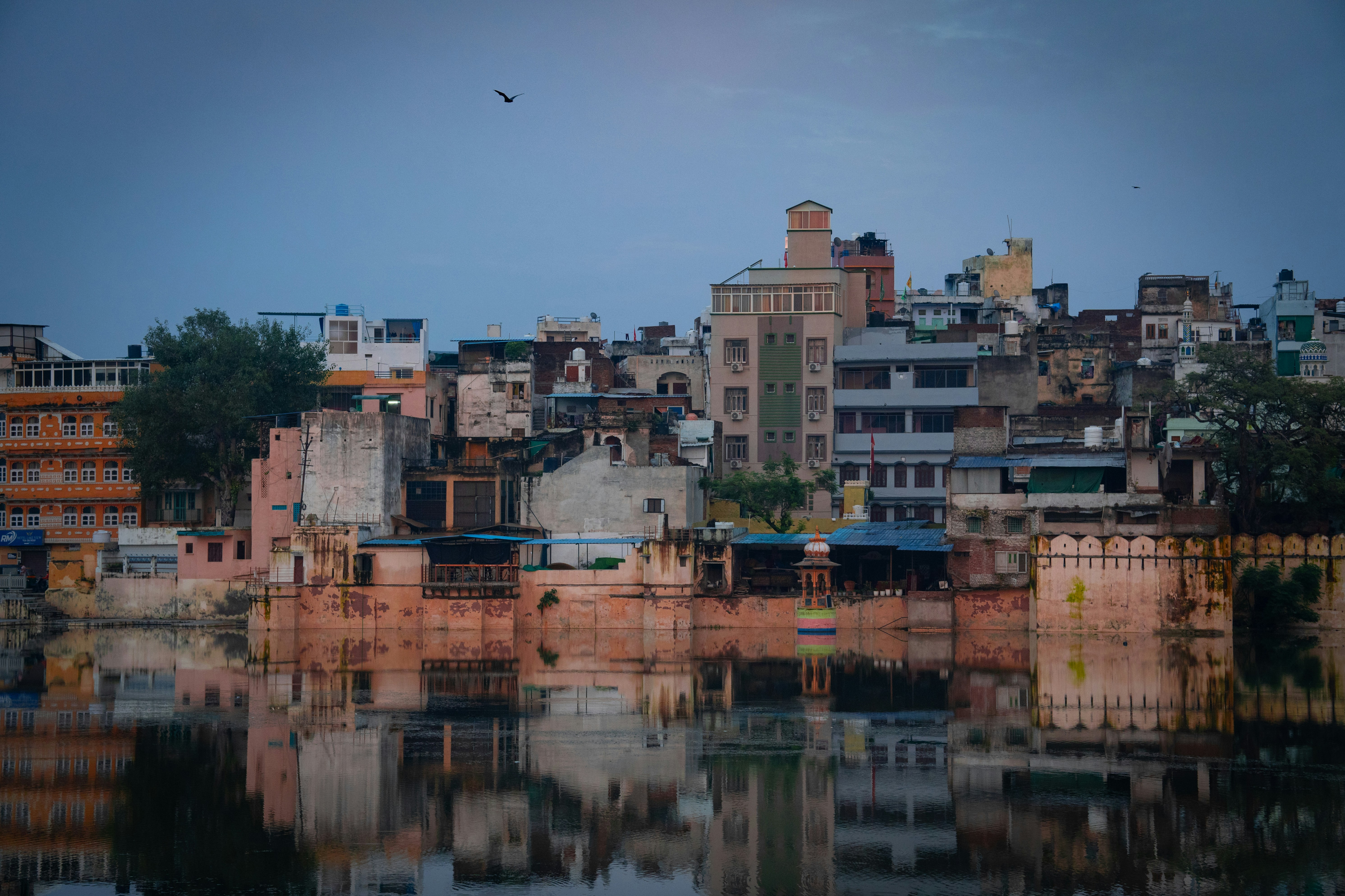 Udaipur, the City of Lakes, glows in the golden hour as its historic buildings reflect off the tranquil waters. A hidden gem of Rajasthan's rich architectural heritage.