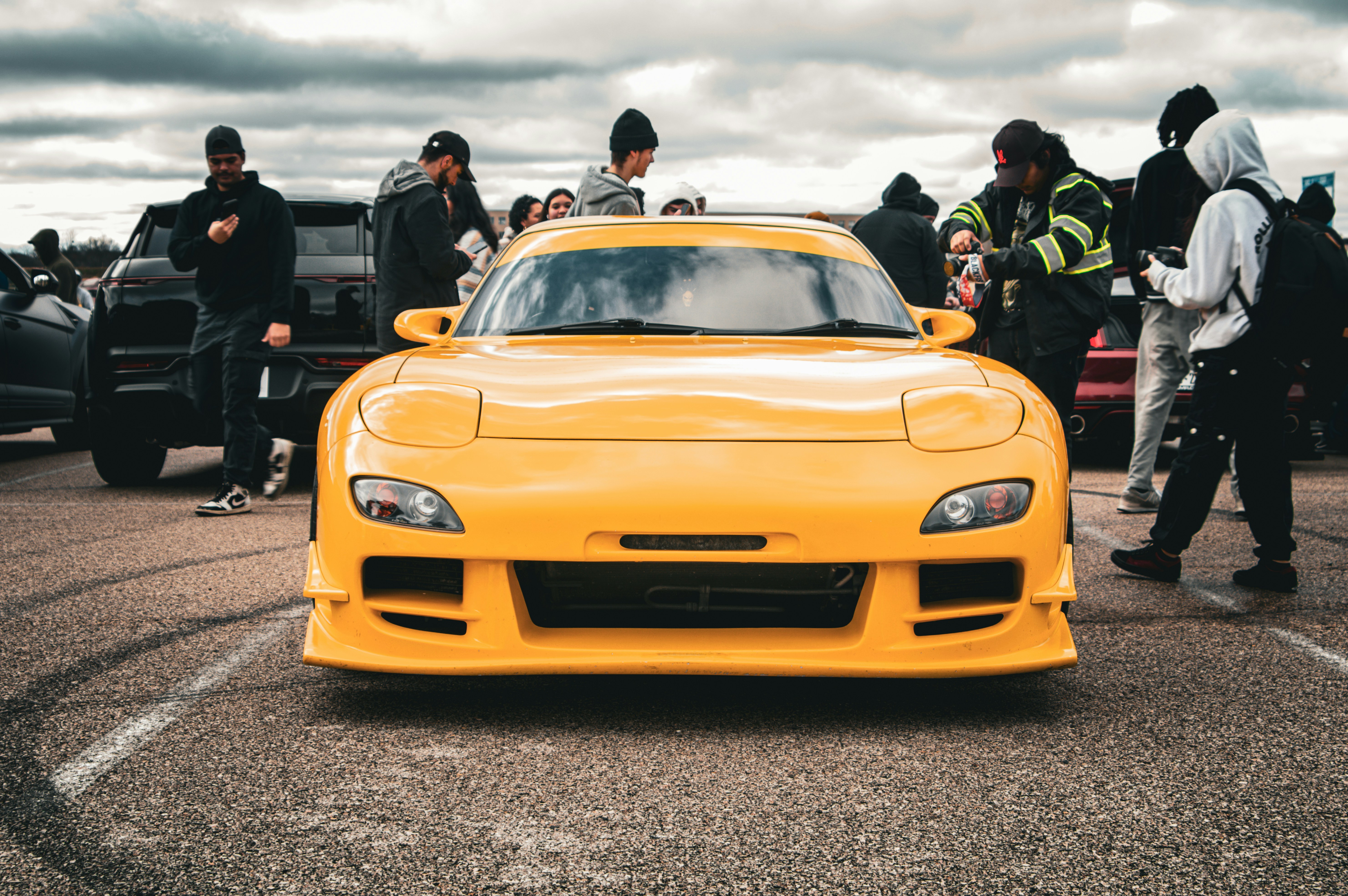 A yellow sports car parked in a parking lot photo – Free Wallpaper ...
