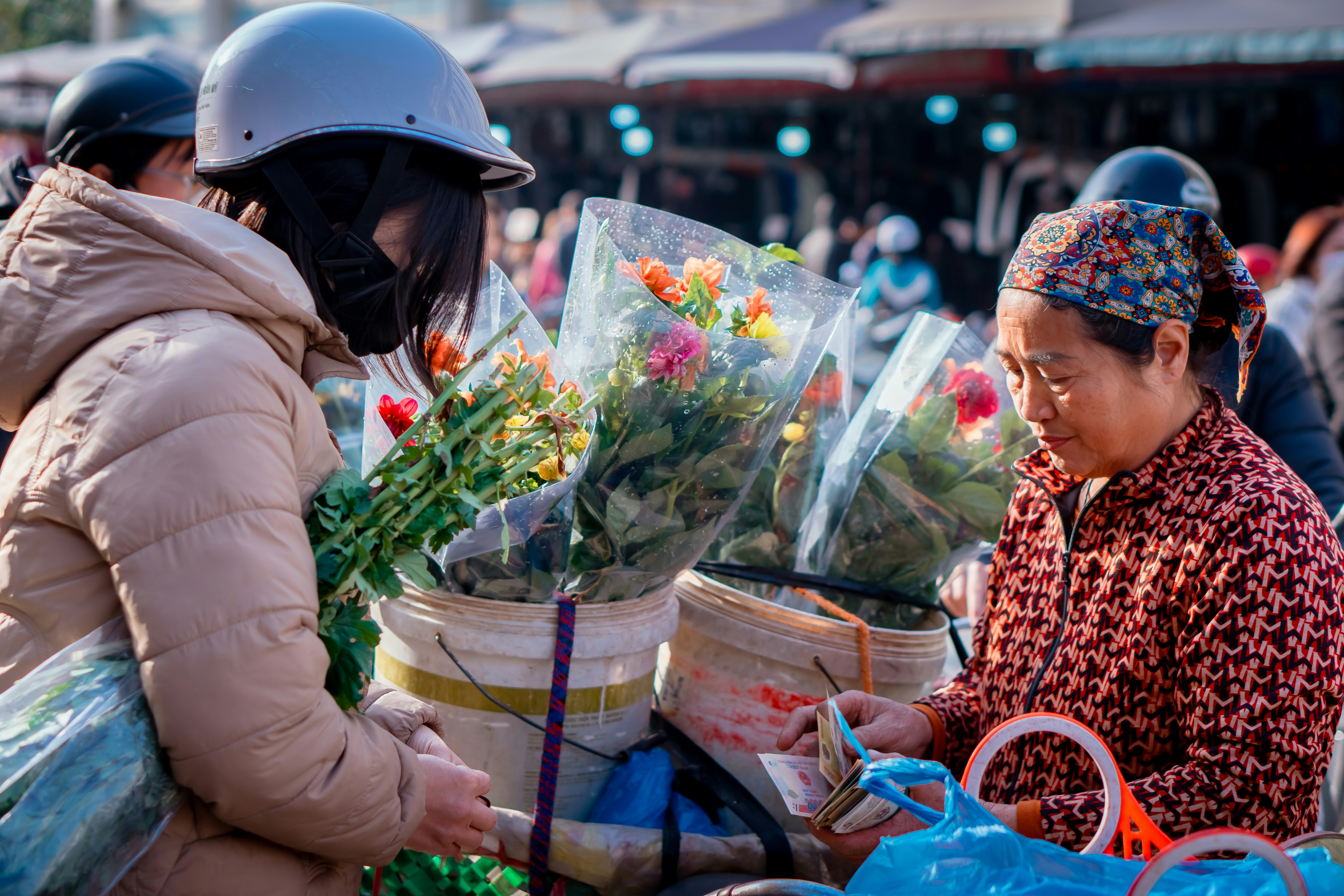 Flowers for Sale: A Moment of Quiet Exchange at the Market Stall