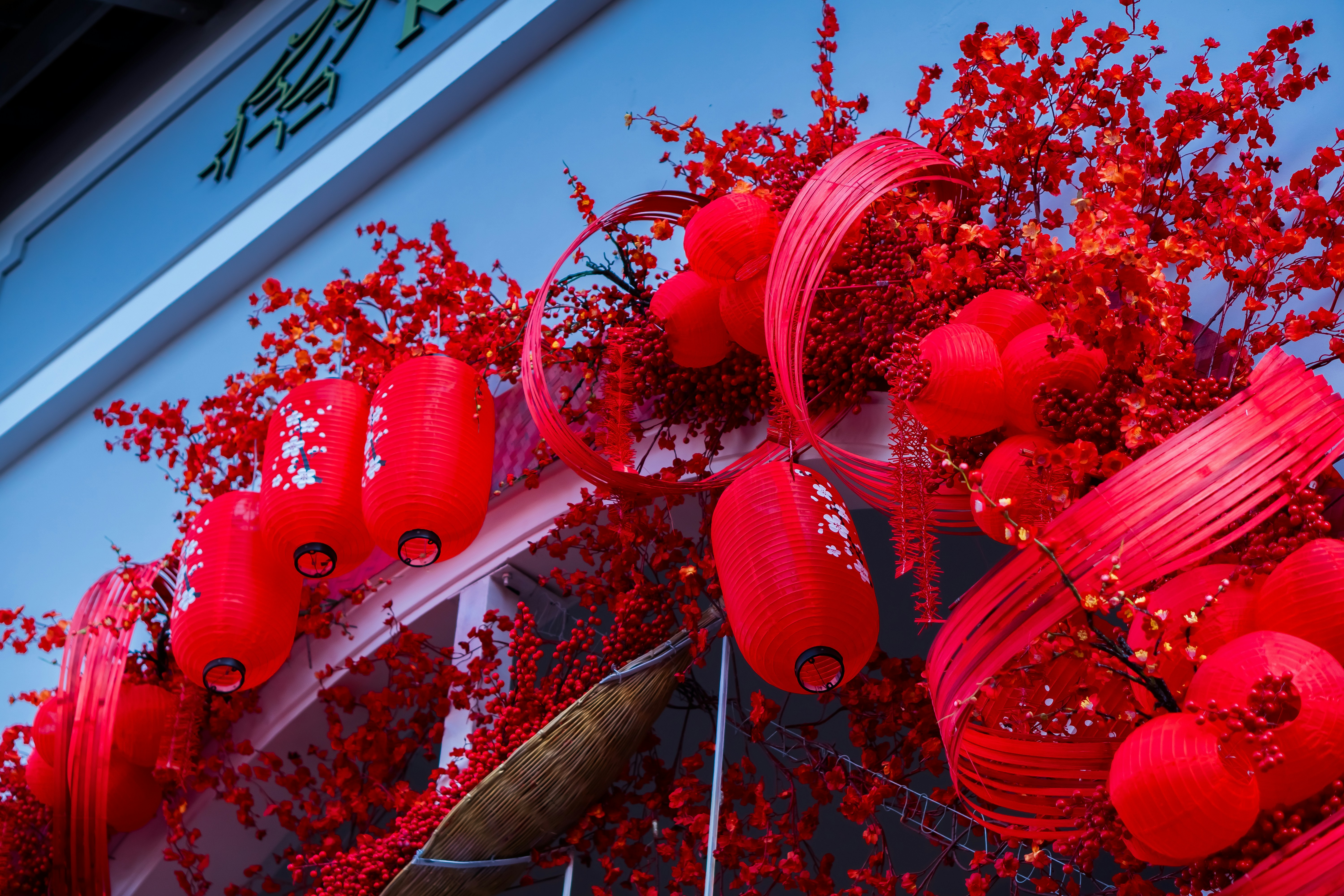 A red wreath is hanging on the side of a building photo – Free Vietnam ...