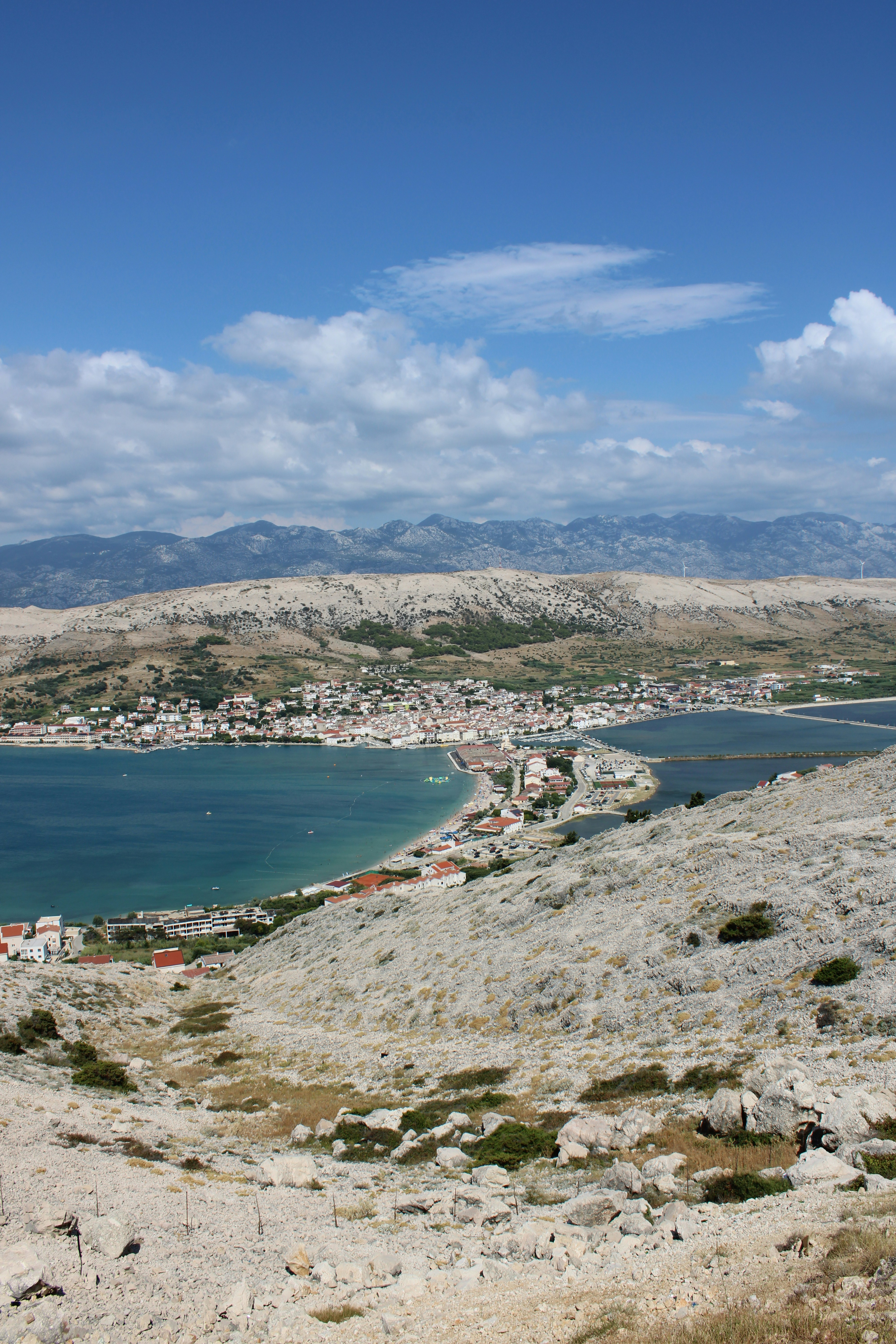 Coastal Crown: limestone hills cradle a sunlit harbor village