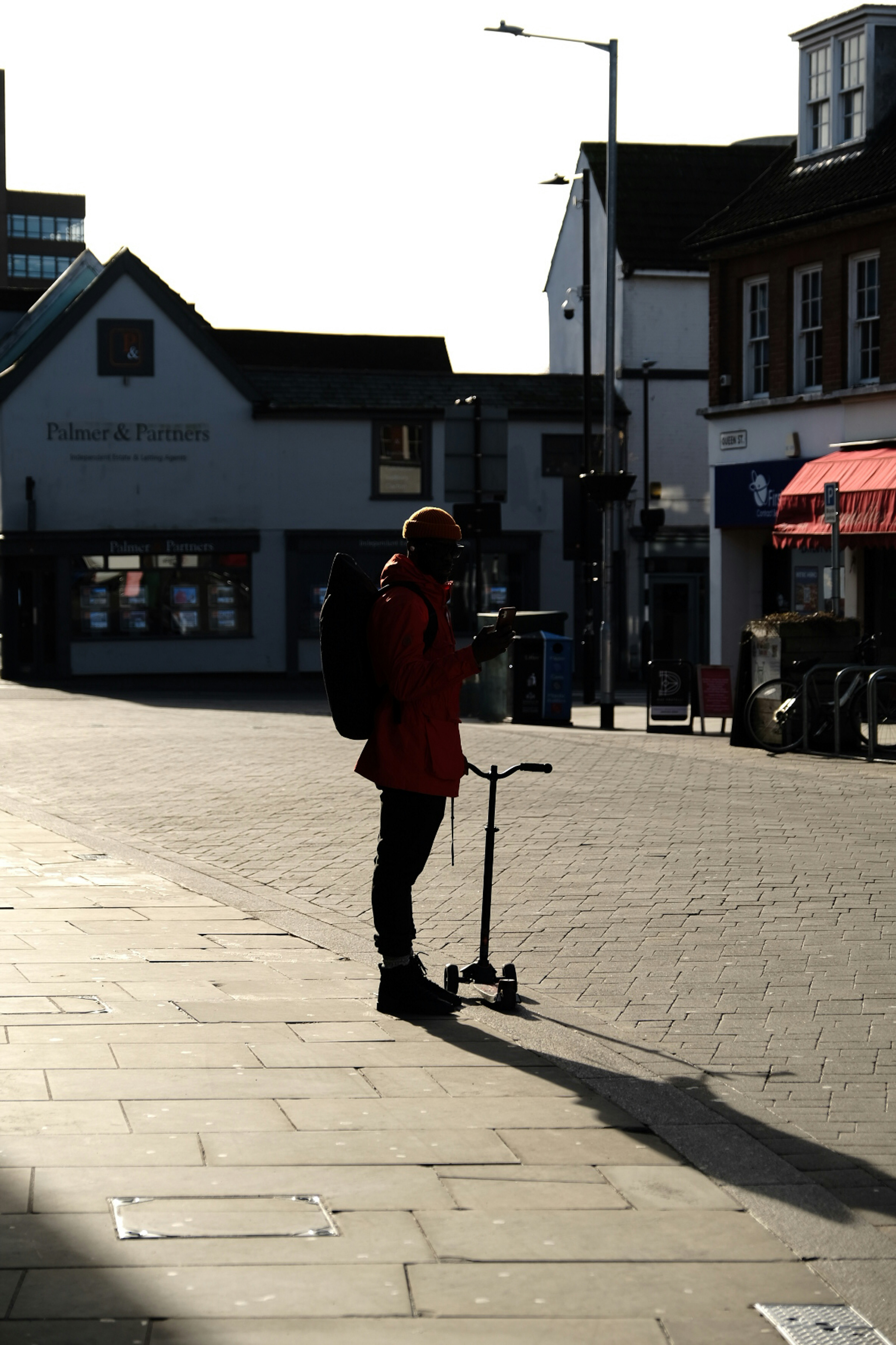 Urban Solo: A Red-Jacket Rider Cast in Soft Streetlight