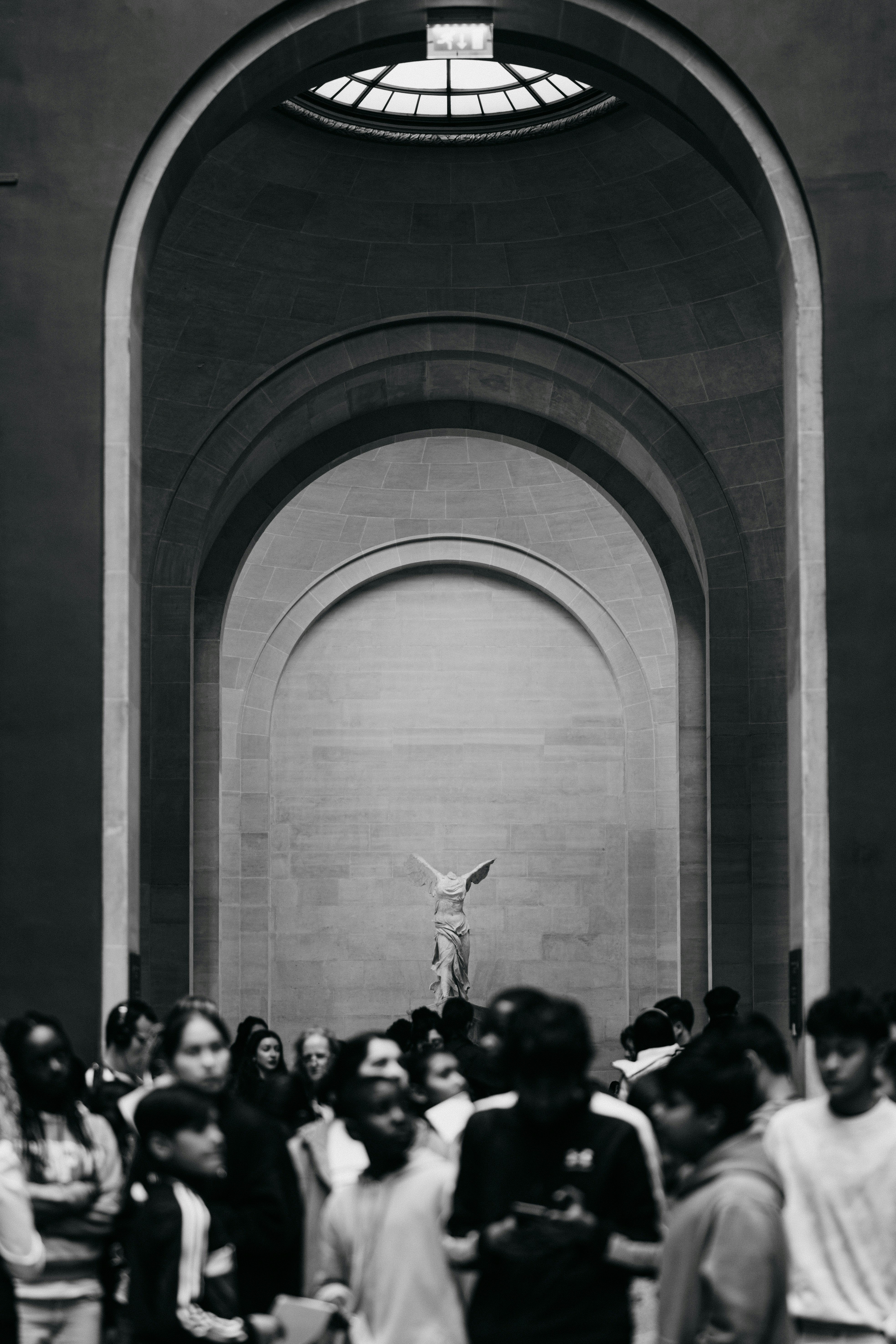 Centerpiece in a Ringed Hall: Winged Statue Beneath Archways