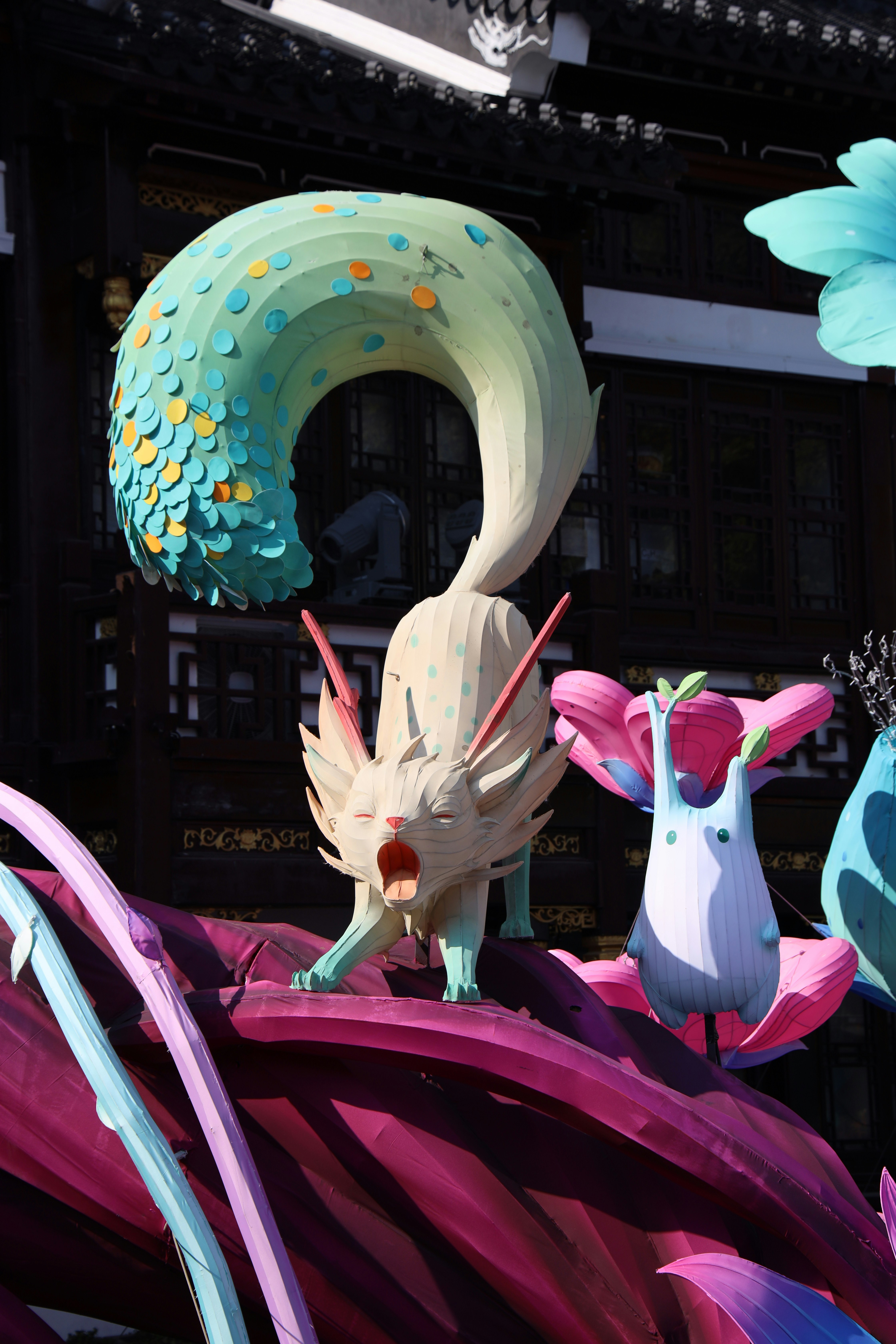 A group of fake animals sitting on top of a lush green field photo ...