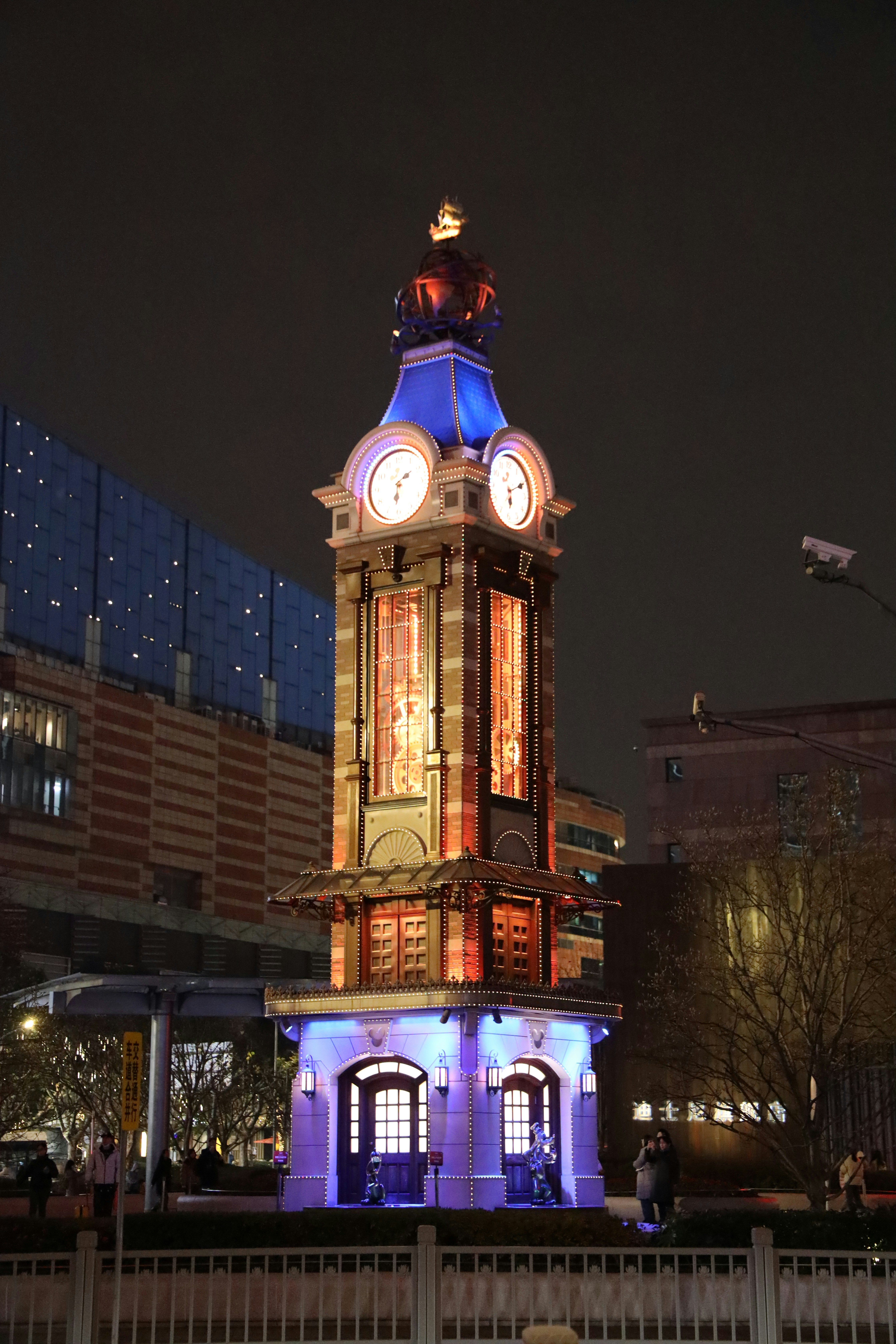 Neon Clock Tower at Night: A Pulsing Beacon in Urban Quiet